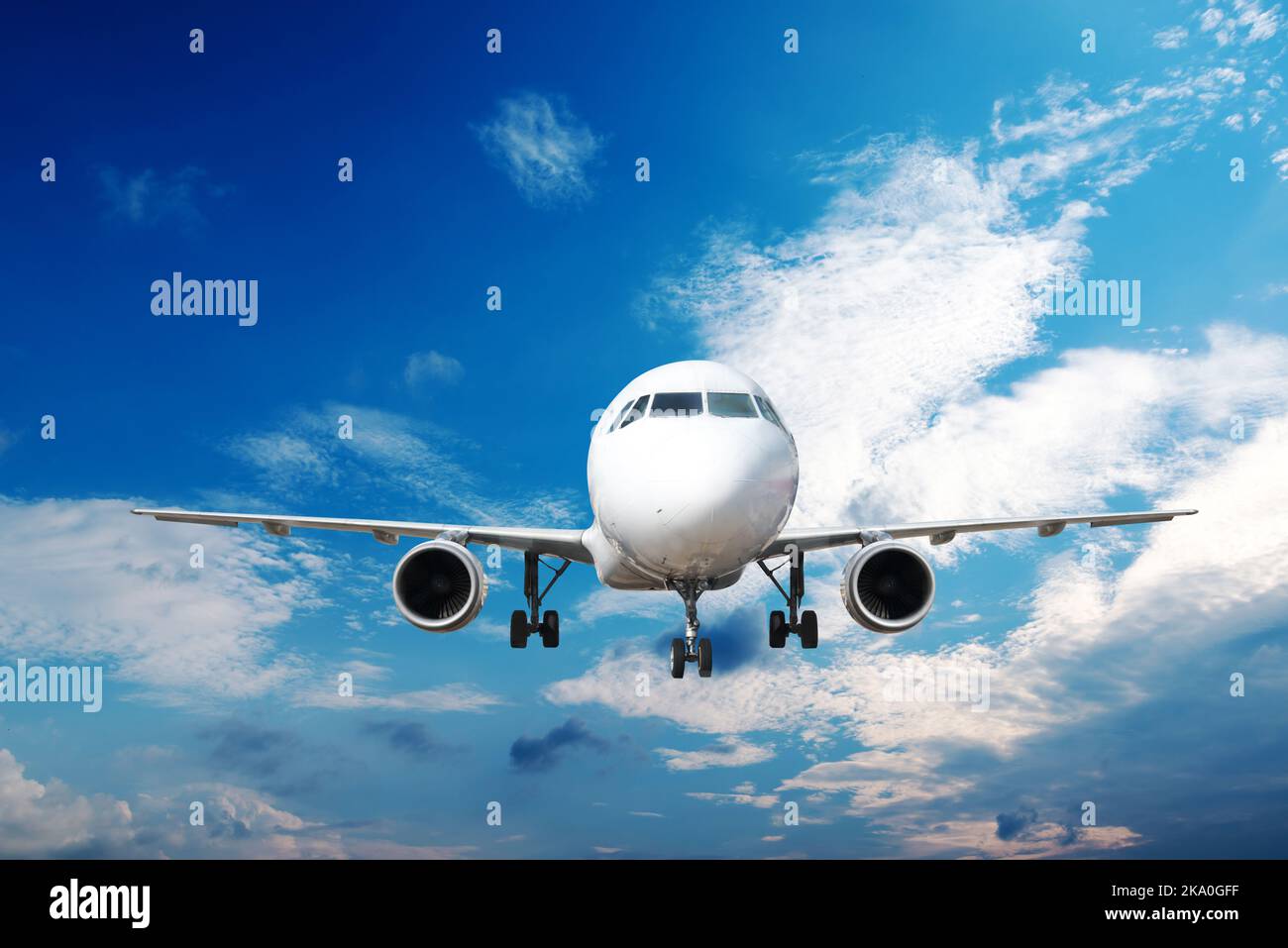 Large passenger plane flying in the blue sky Stock Photo - Alamy