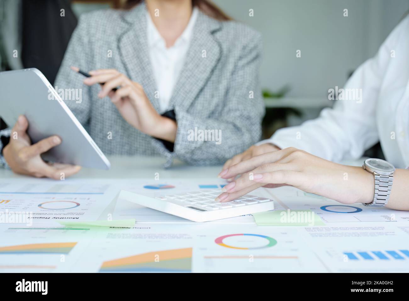 young Asian businesswoman using tablet computers to plan marketing ...