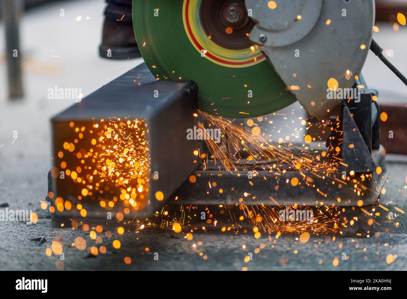 Worker cutting steel square pipe in constuction site Stock Photo - Alamy