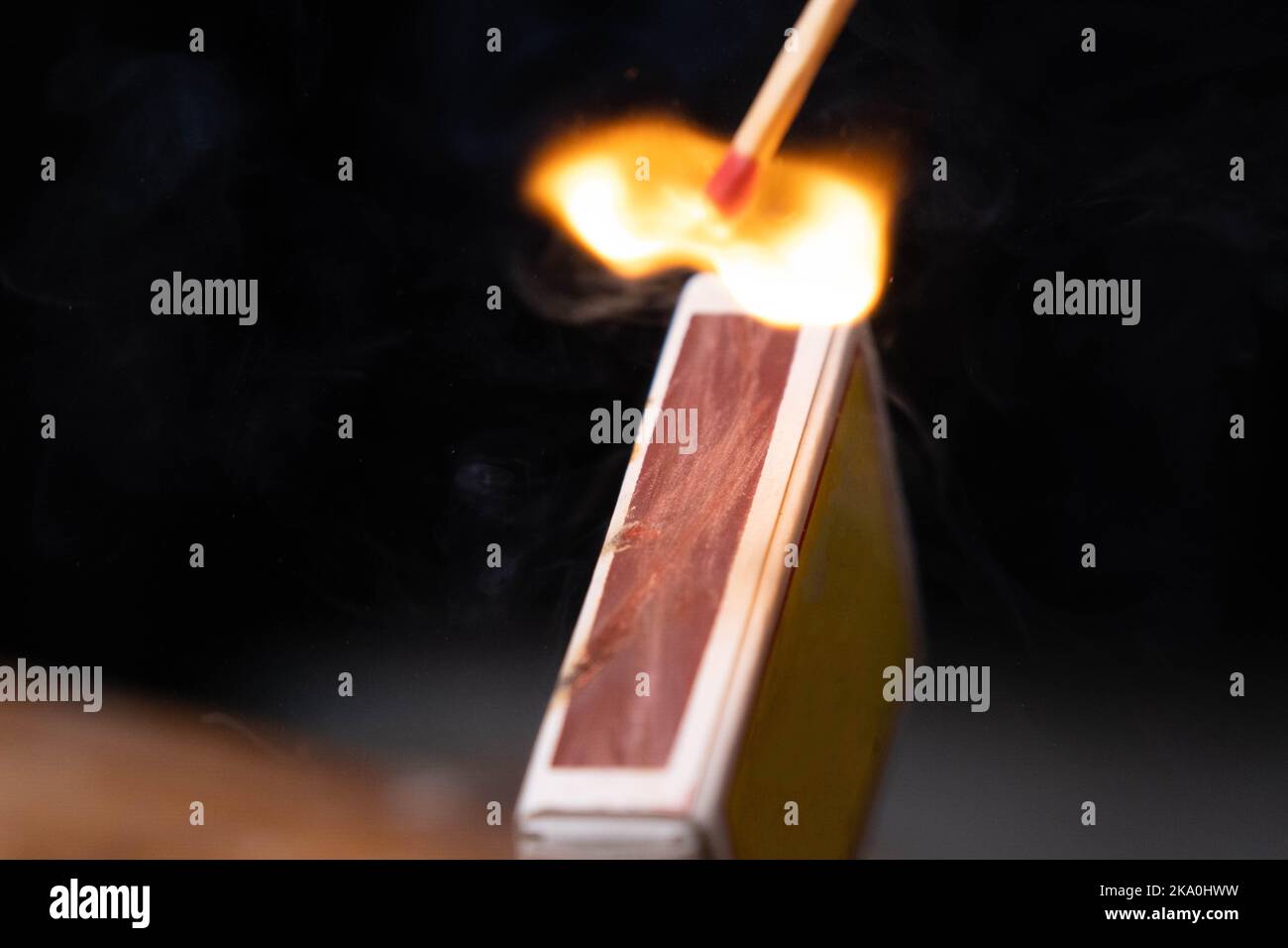 Matchstick fires on matchbox in slow motion close-up. The match was ...