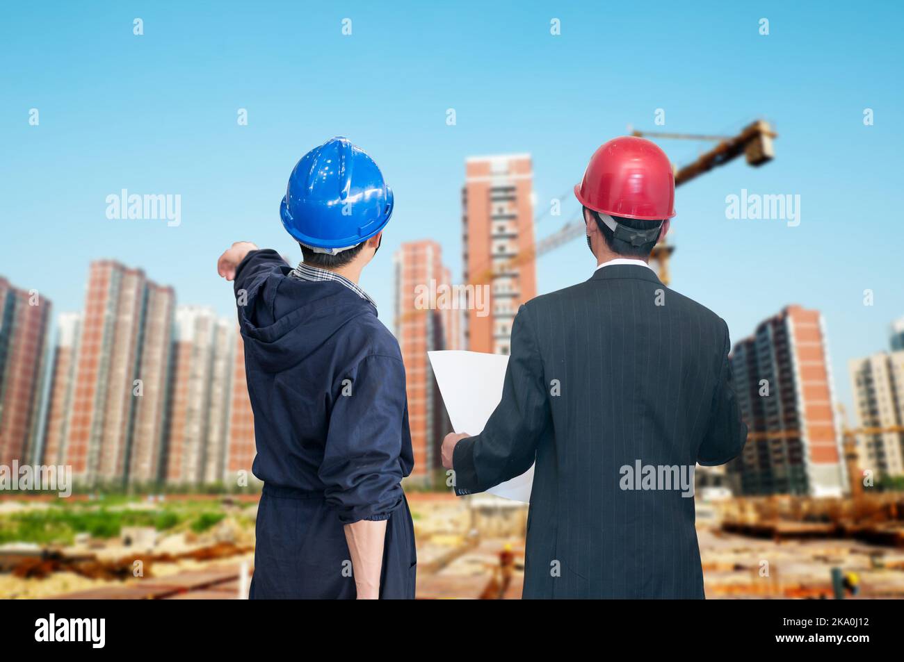 architects looking at blueprint in front of construction site Stock ...