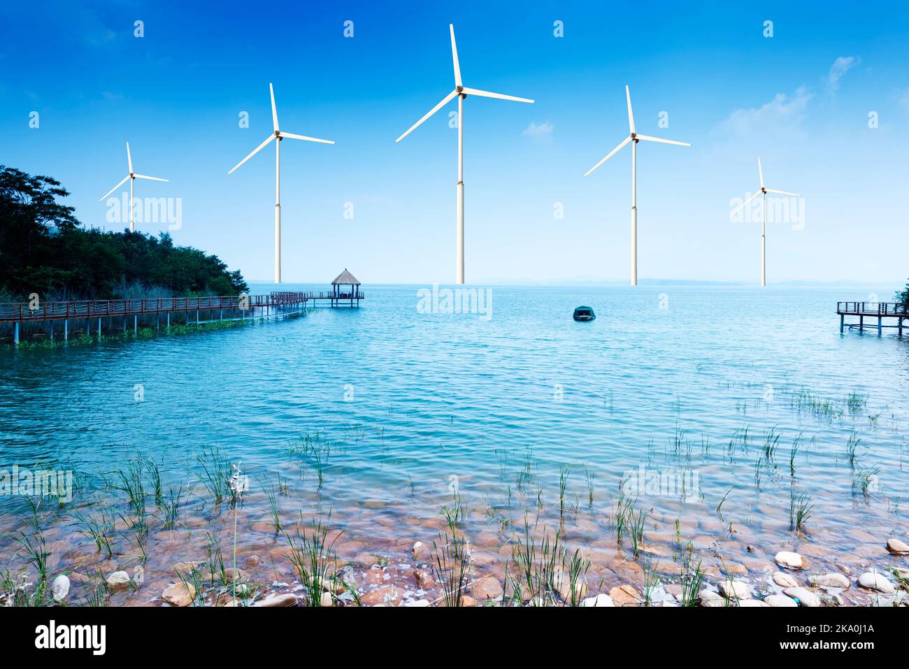 white wind turbine generating electricity on sea Stock Photo - Alamy