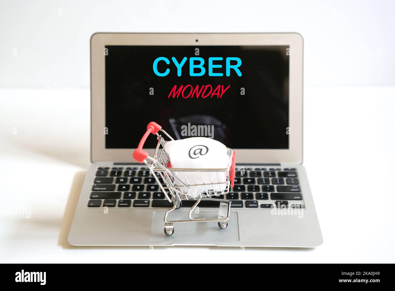 Cyber Monday message on computer laptop screen, with mini shopping cart ...