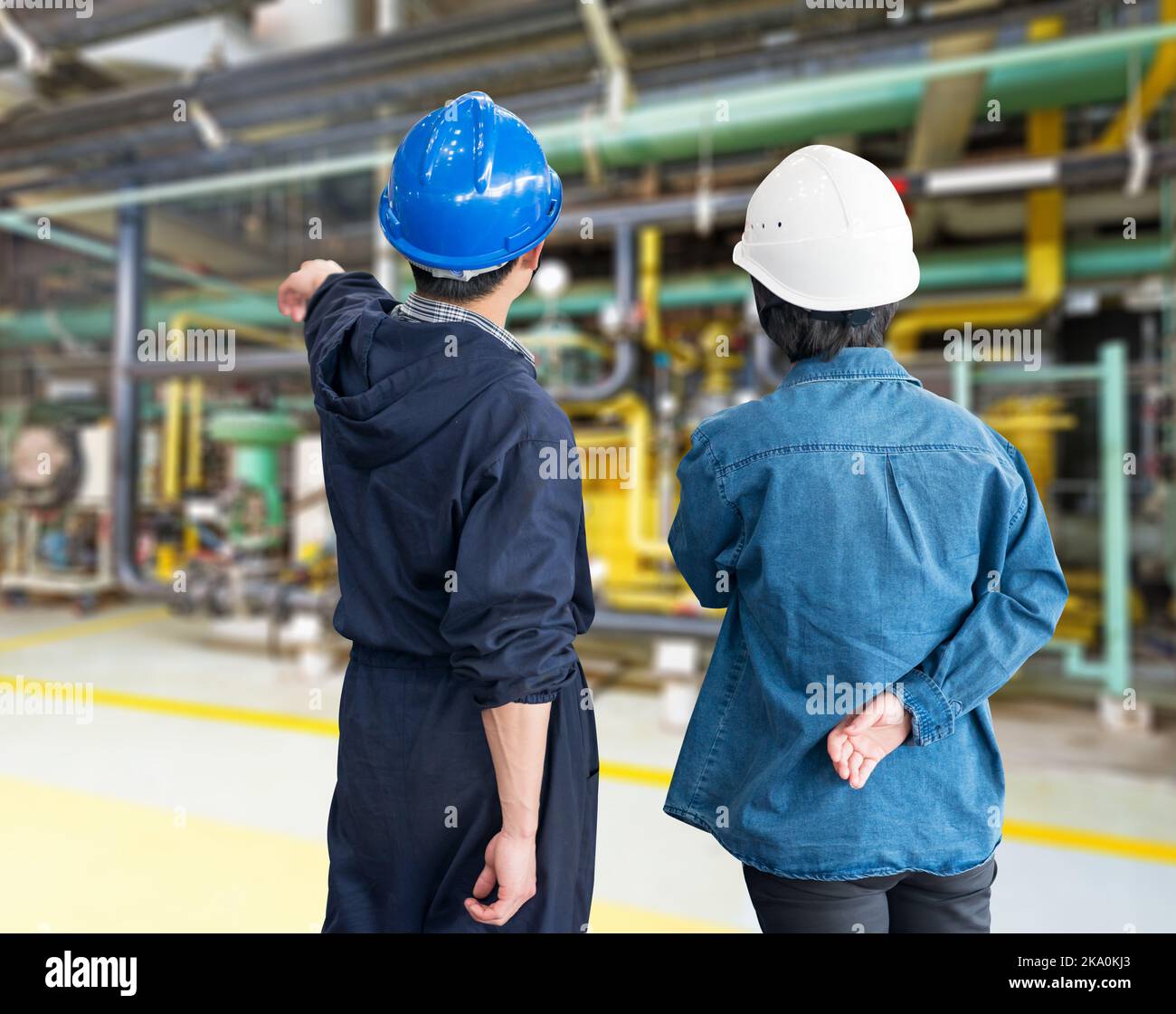Two factory workers pointing hi-res stock photography and images - Alamy
