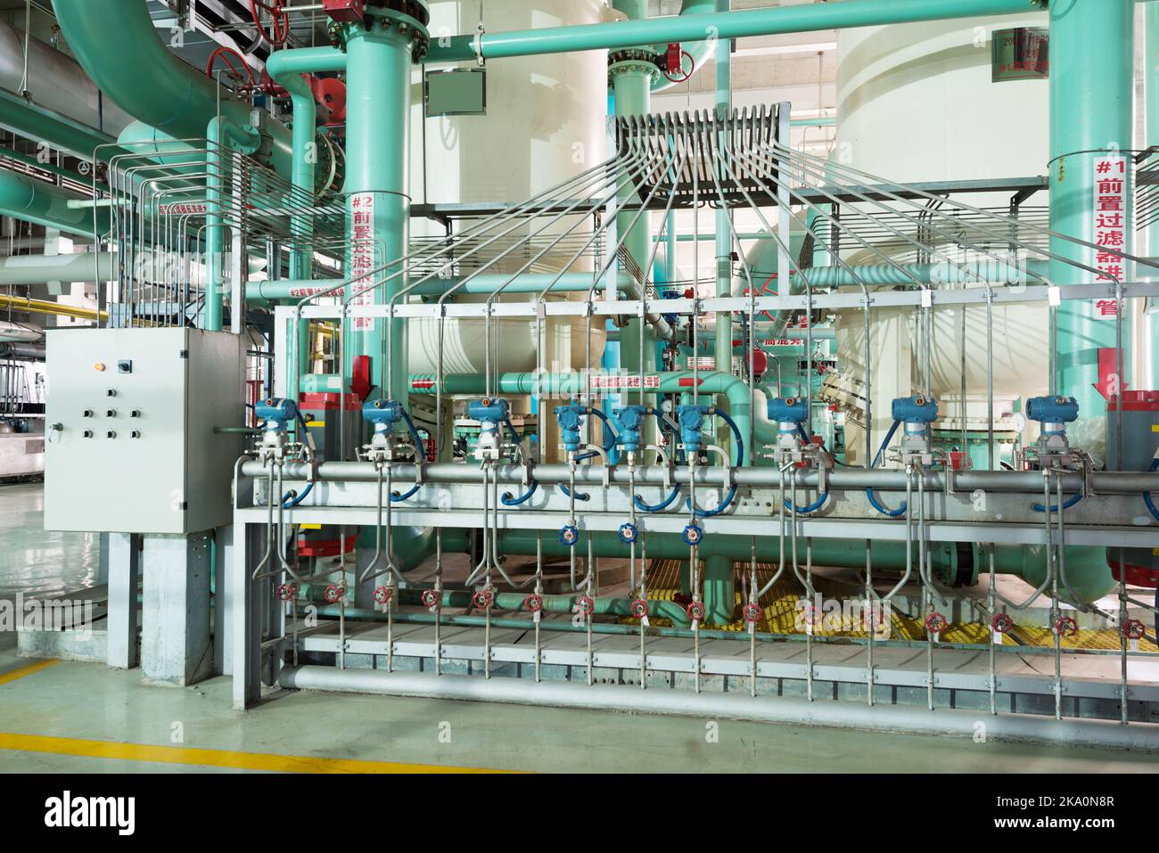 Equipment, cables and piping as found inside of industrial power plant ...
