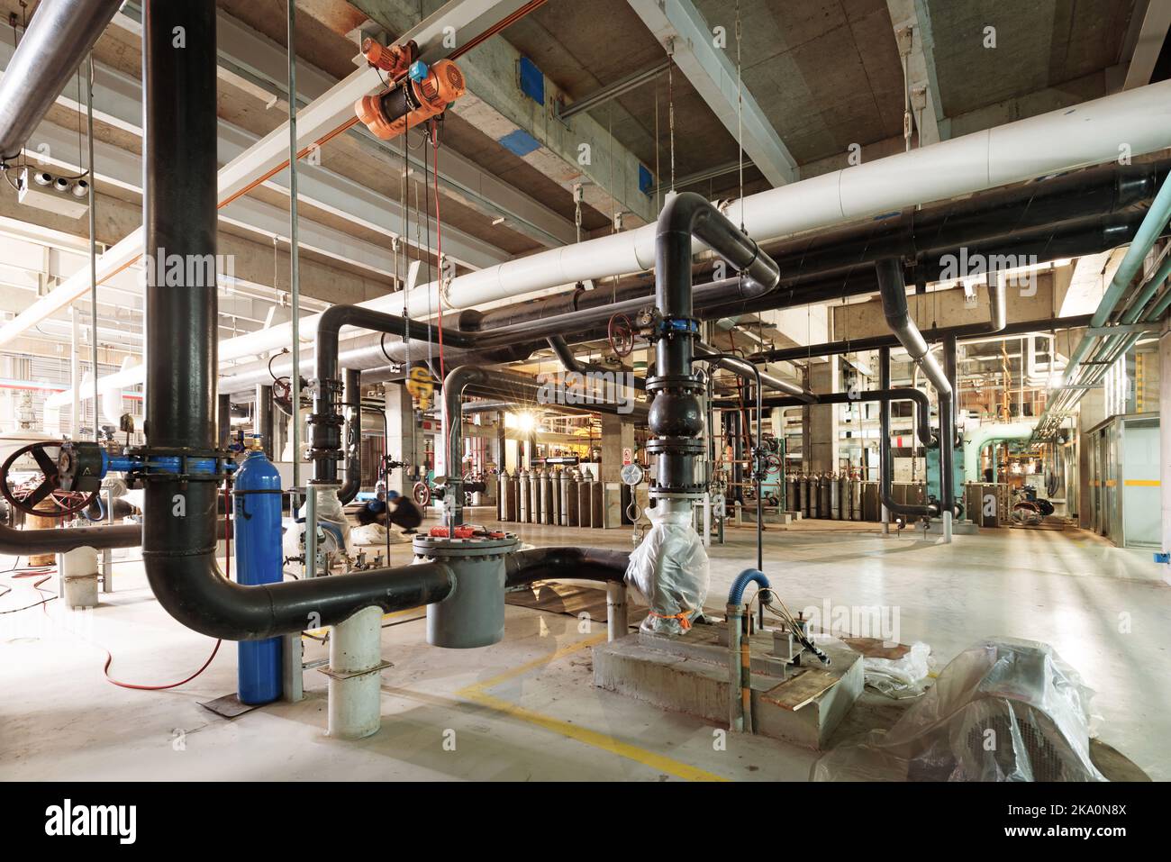 Equipment, cables and piping as found inside of industrial power plant ...