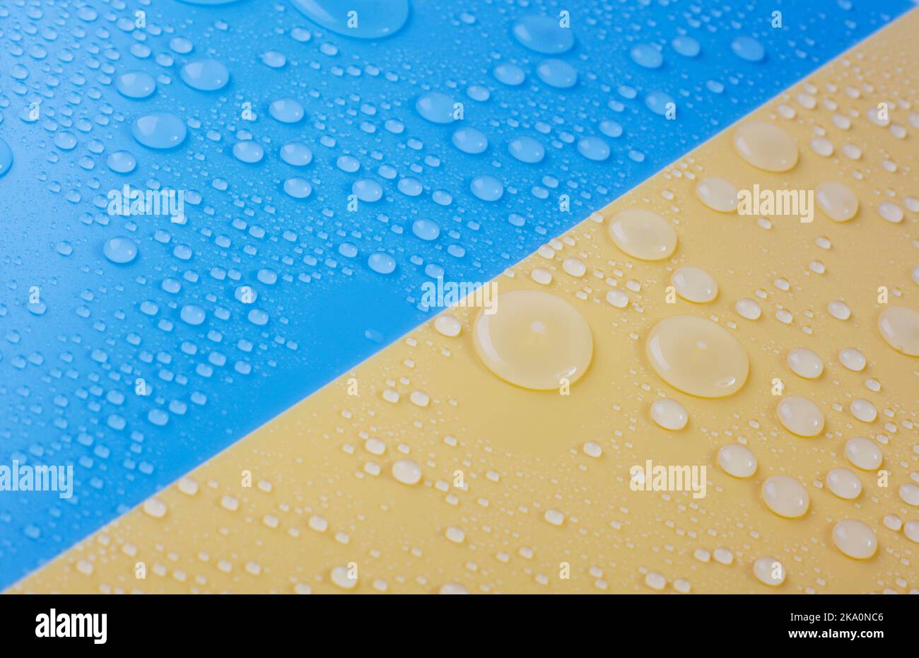 Waterdrop on blue and yellow background Stock Photo - Alamy