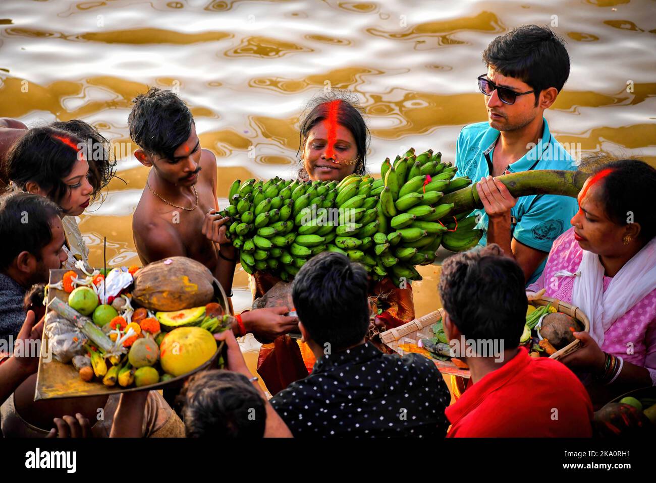 Devotees are seen offering prayers and food items as gift to Sun god on ...