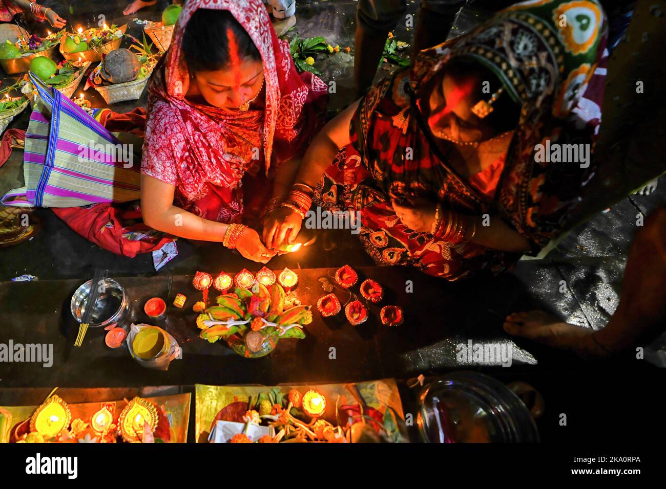 Hindu devotees are seen performing evening rituals on the occasion of ...