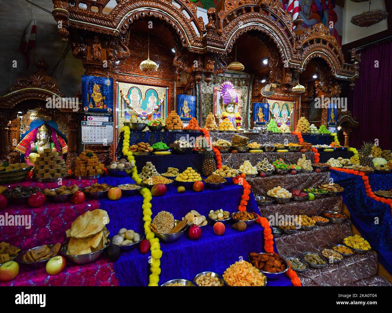 Food is placed before deity's at an altar for Diwali. Diwali is the ...