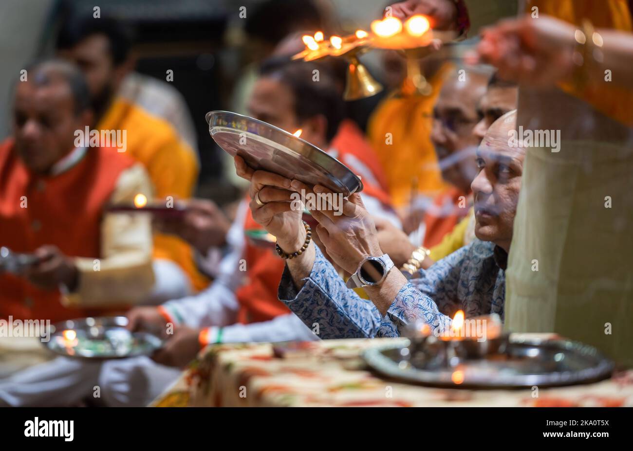 Men hold candles to dieties during a Diwali celebration. Diwali is the ...