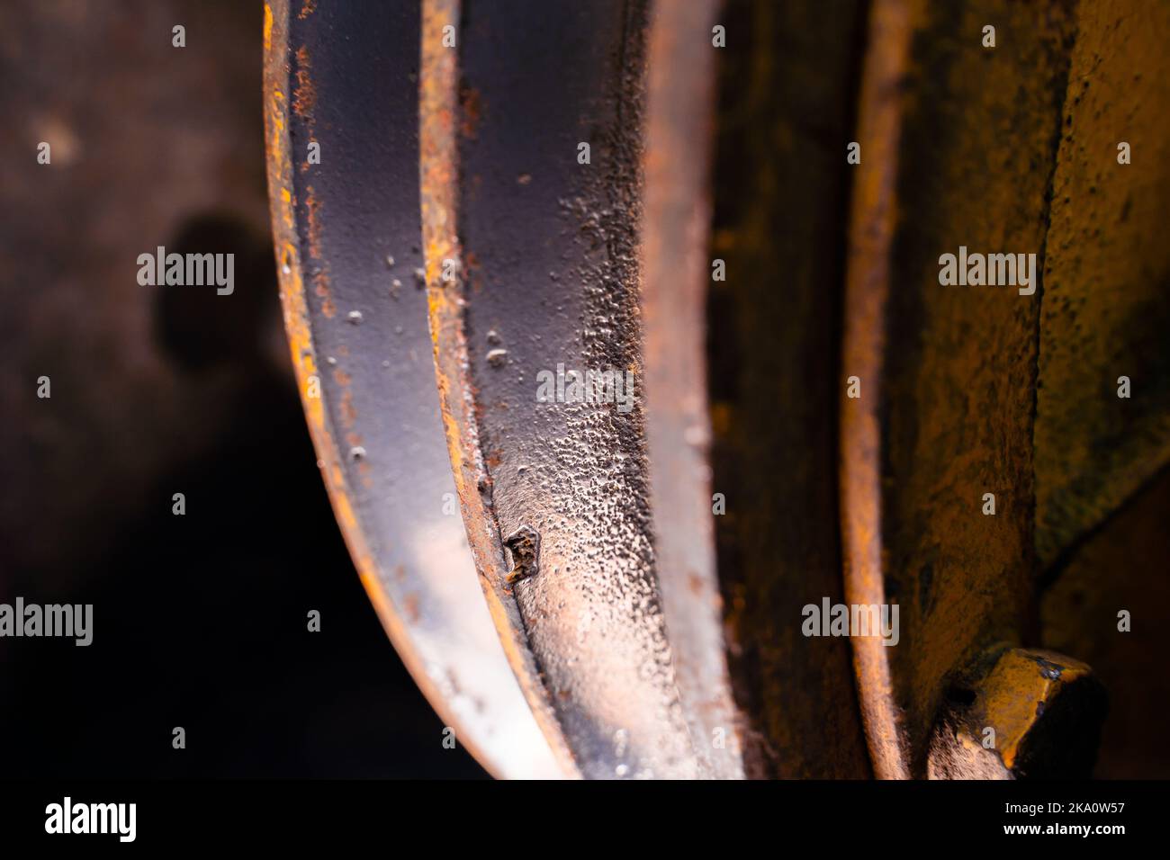 V-pulley with corrosion in the recesses close-up. Old worn double ...