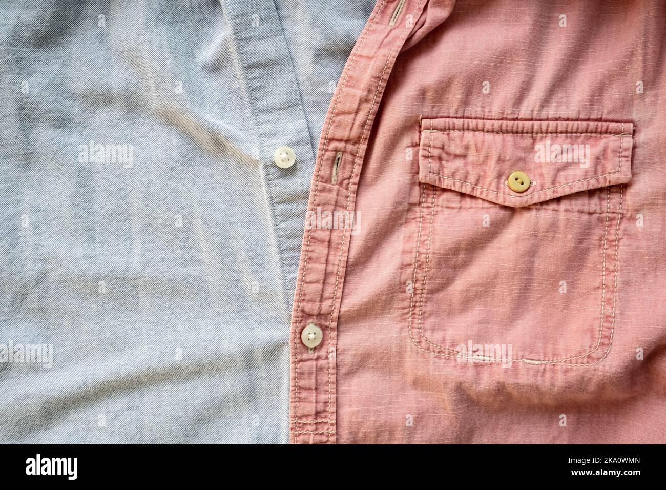 Different shirts are buttoned together. Fabric background in pink and ...