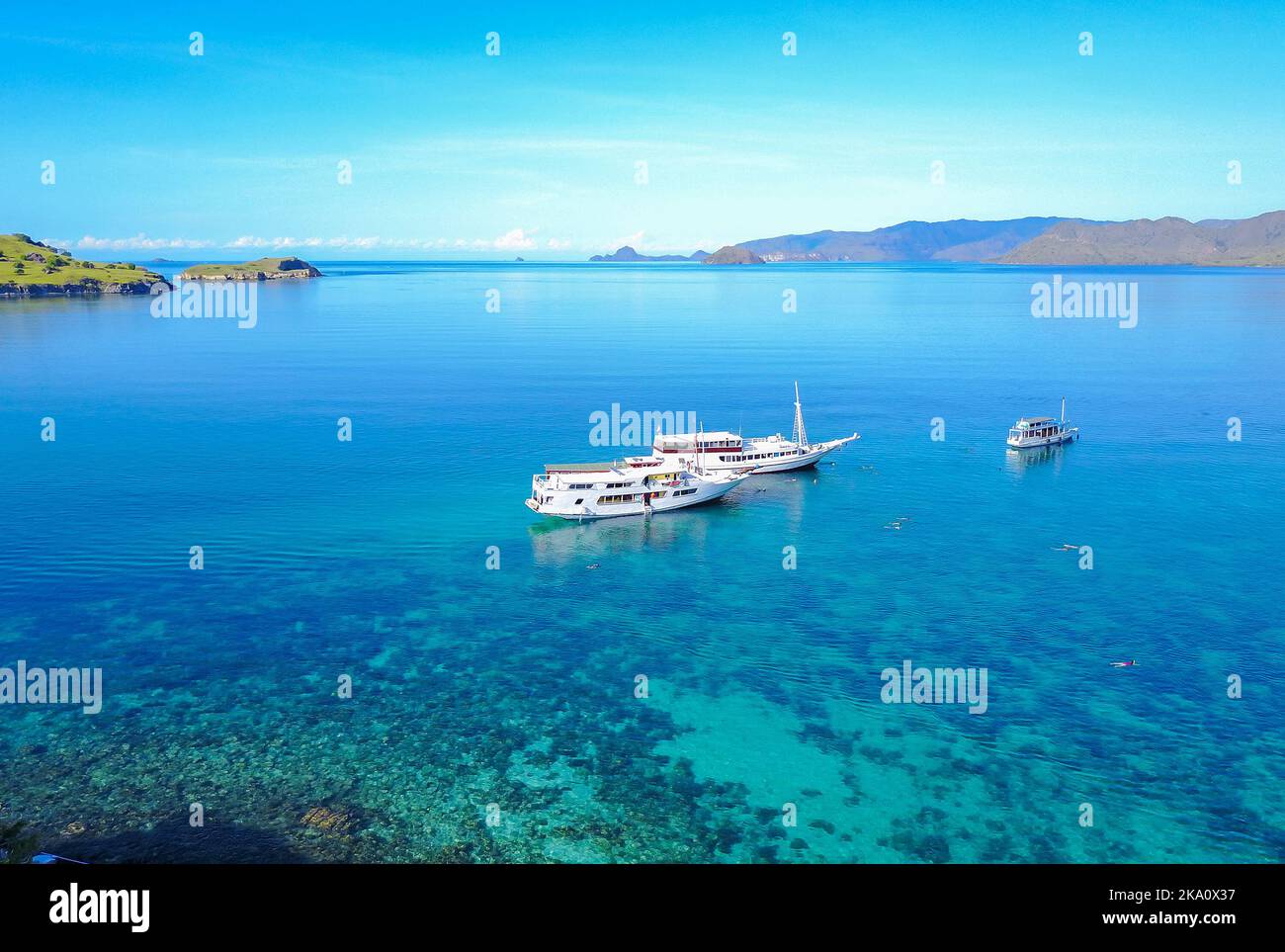 Tourist boats at Gili lawa island with a clear blue sea, Flores ...