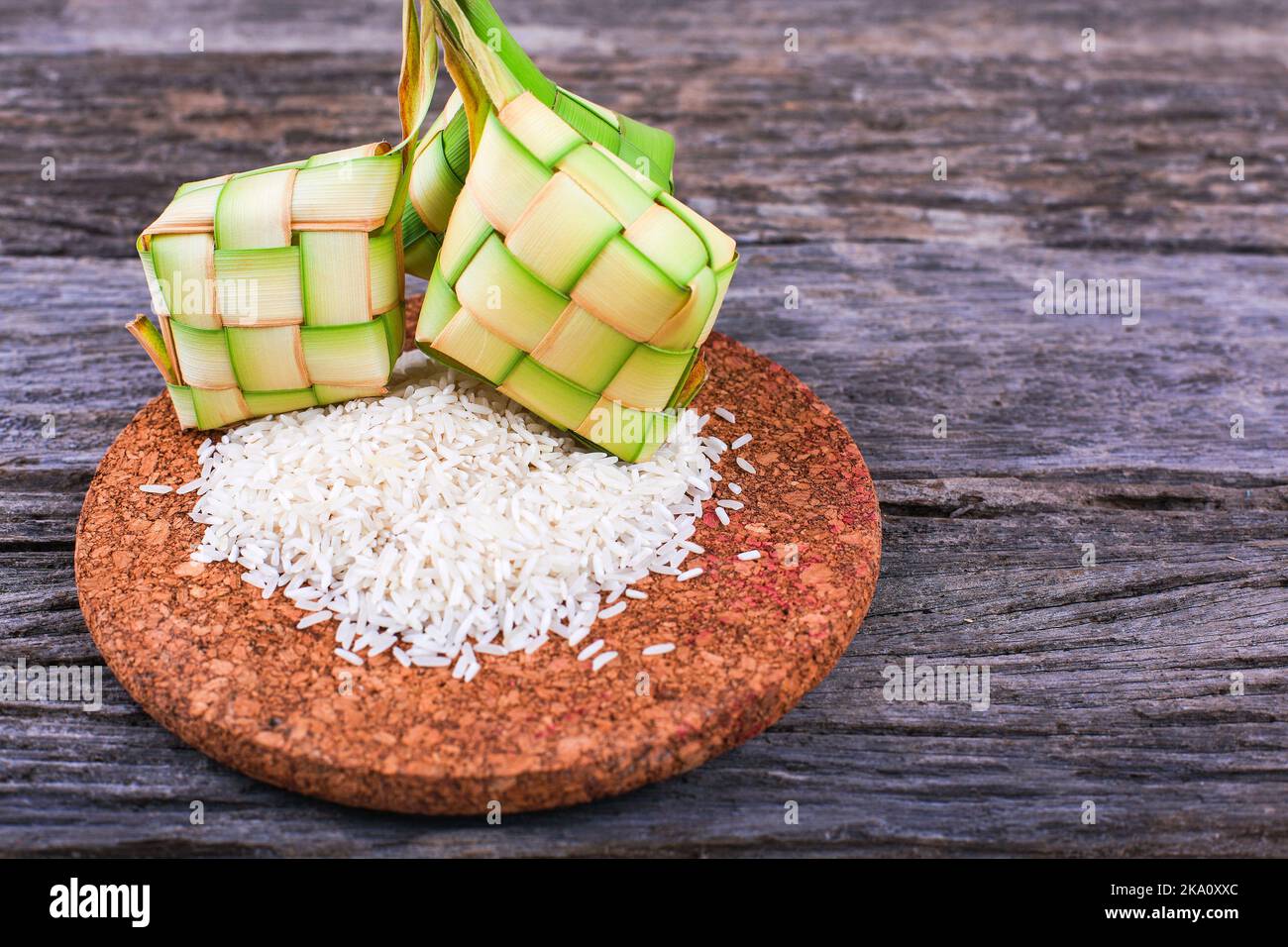 Ketupat (Rice Dumpling) and rice On Wood Background. Ketupat is a ...
