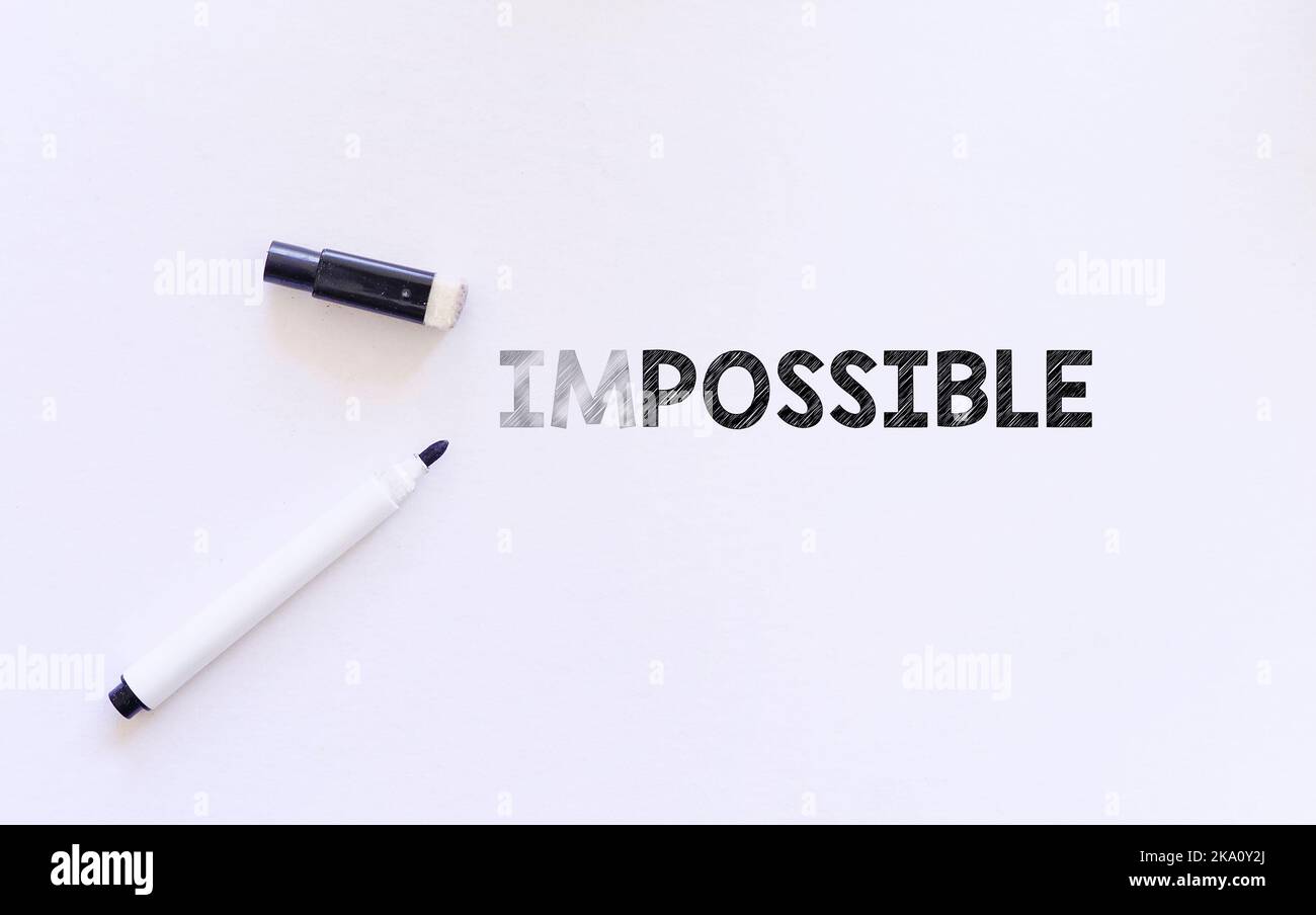eraser on white paper erase letters "IM" from the word IMPOSSIBLE into ...