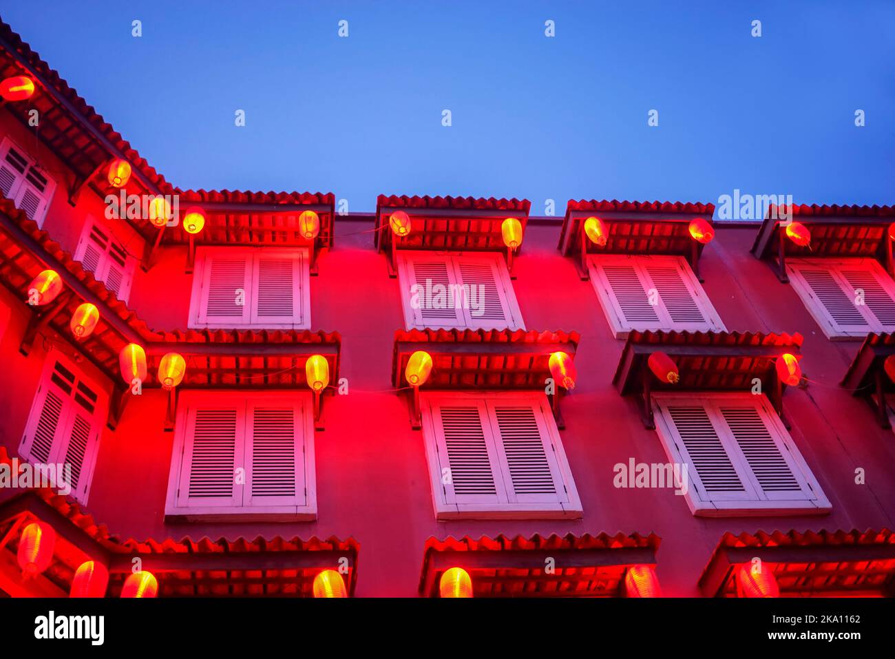 Red building and lantern during blue hour Stock Photo - Alamy