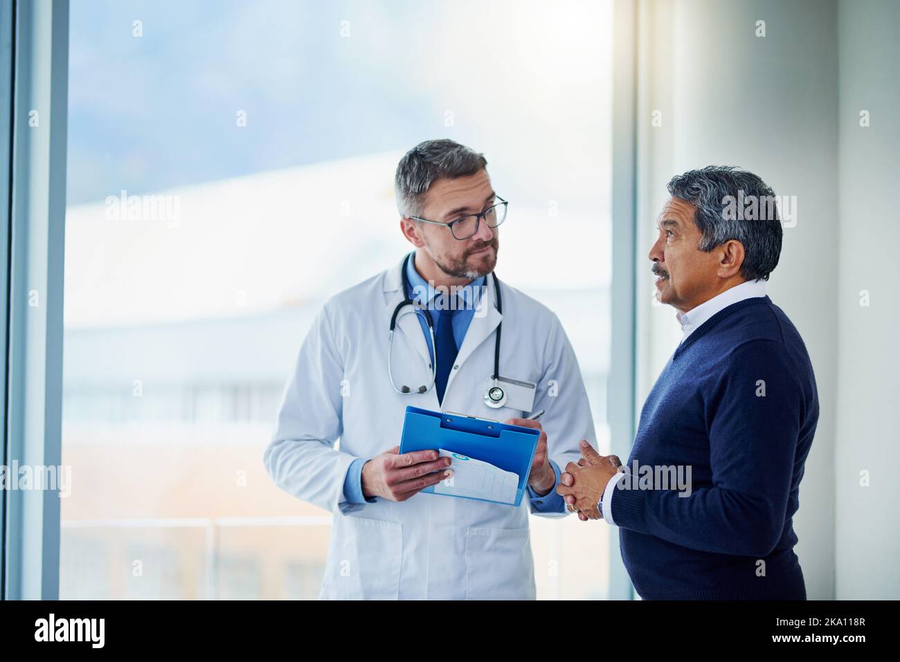 Describing all his symptoms down to the detail. a mature doctor having ...
