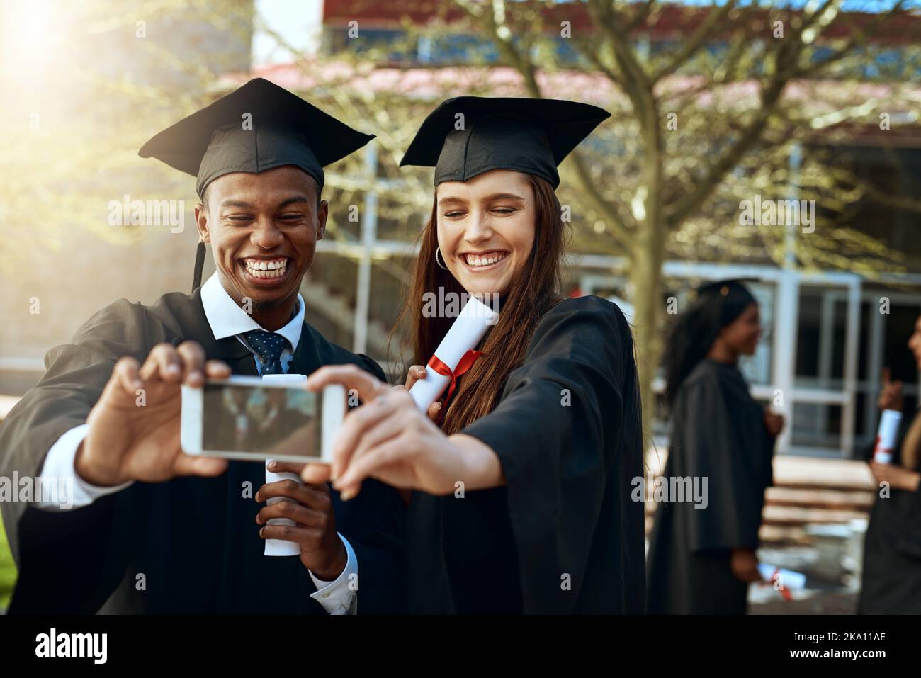 Its finally happening for us. a young man and woman taking selfies with ...