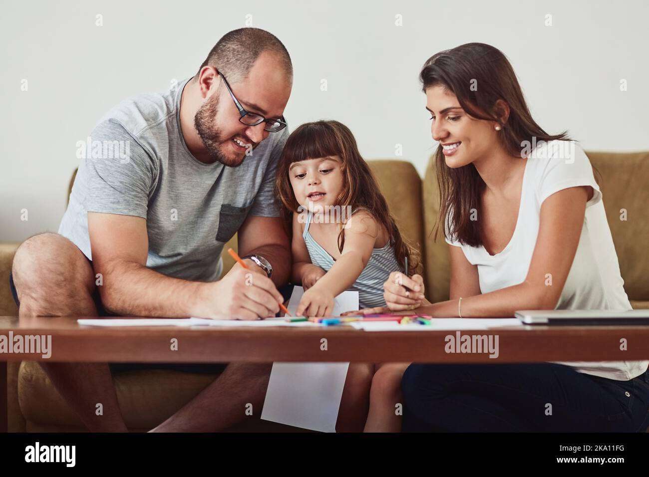Nurturing her creative side. a mother and father drawing together with ...