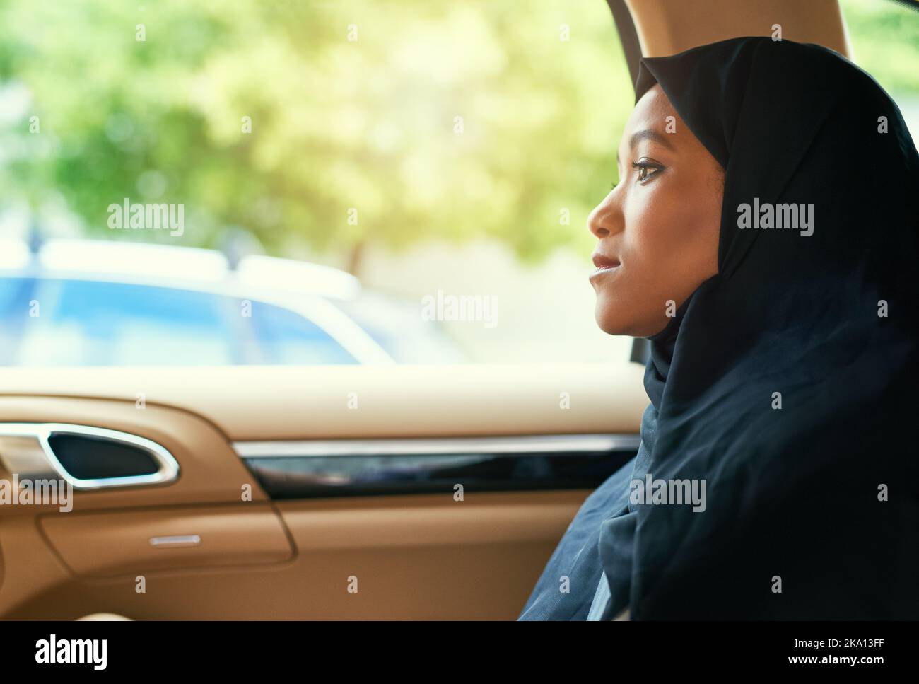 Waiting to get passed all these cars. a confident young businesswoman ...