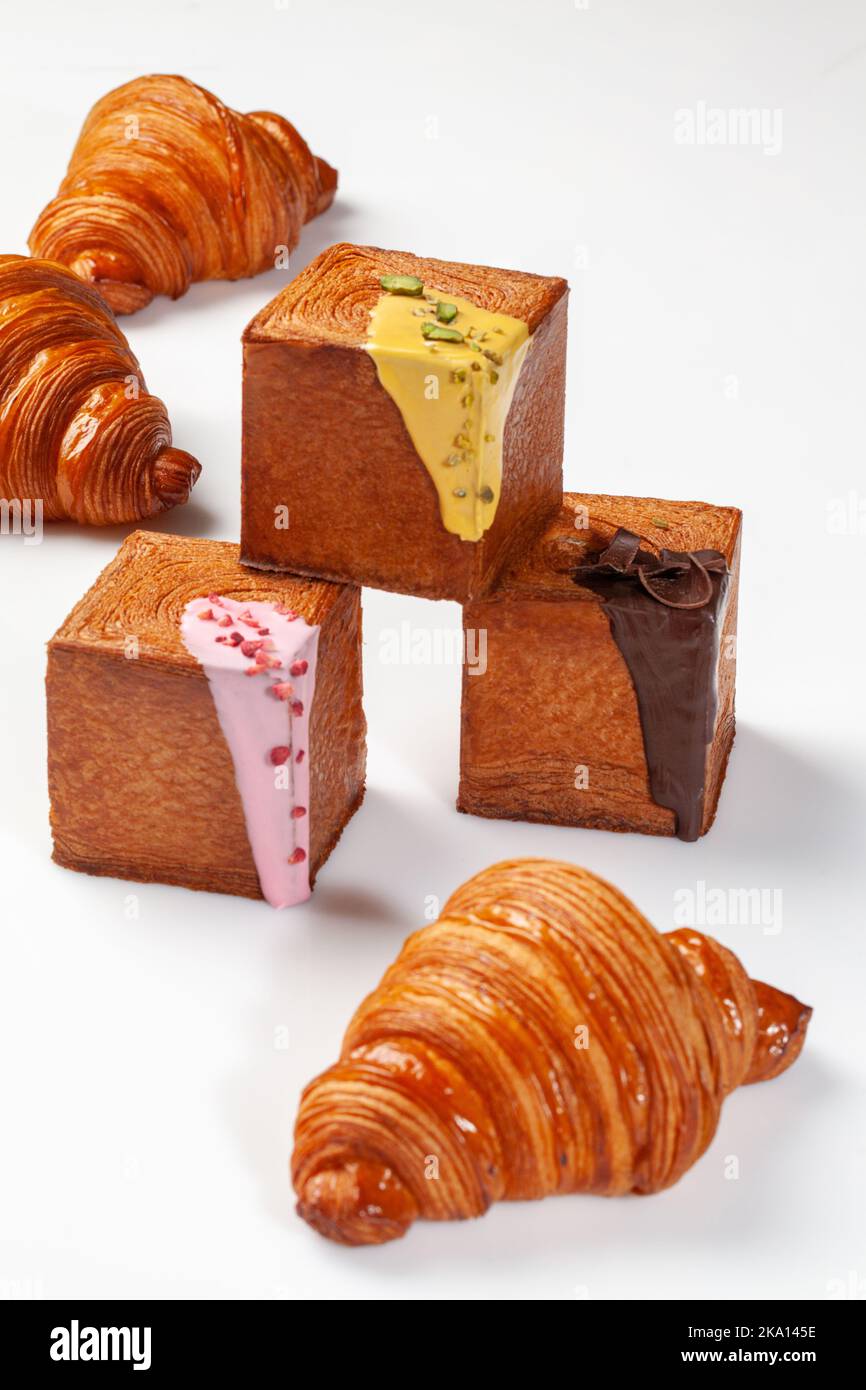 French crescent and cube shaped croissants with sweet sauces, chocolate ...