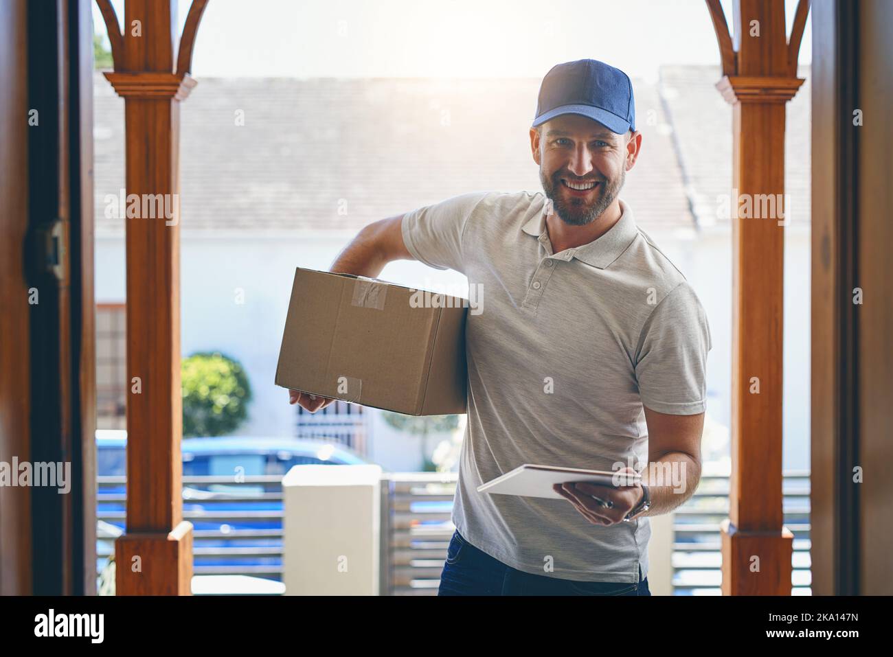 Delivery man reporting for duty. Portrait of a courier making a home ...