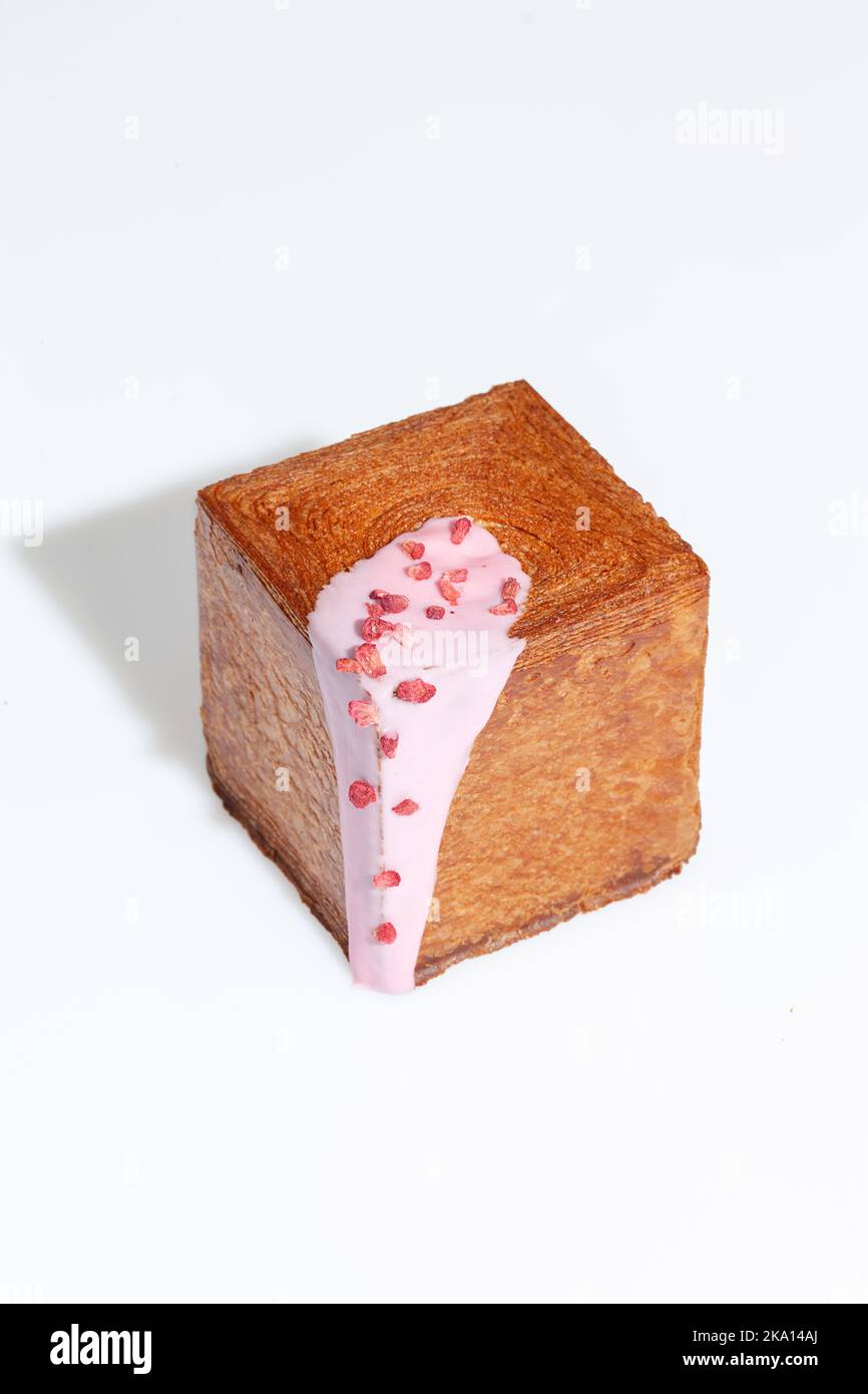 Puff pastry cube shaped croissant with creamy berry sauce and candied ...