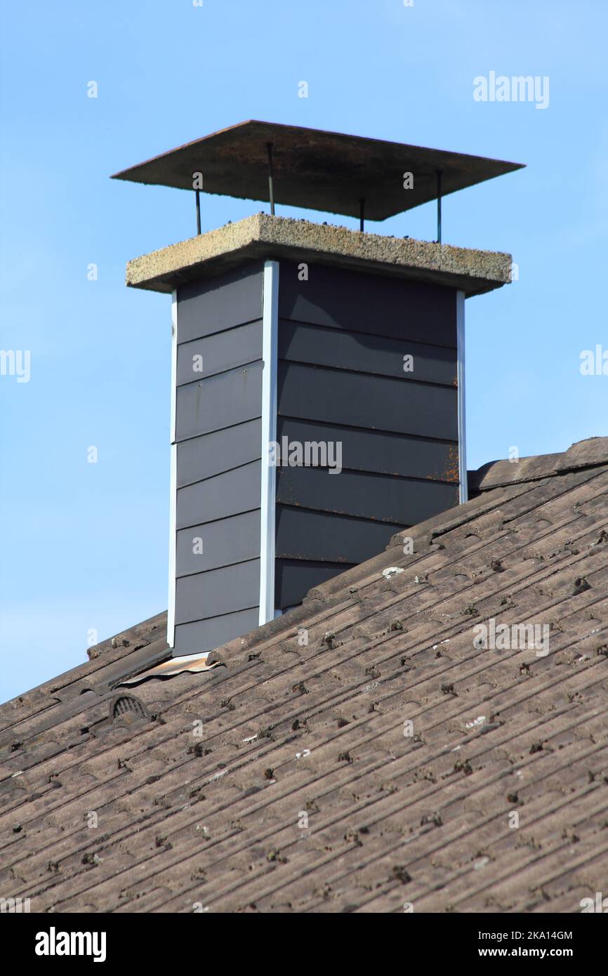 clad in slate shingles chimney, blue sky in background Stock Photo - Alamy