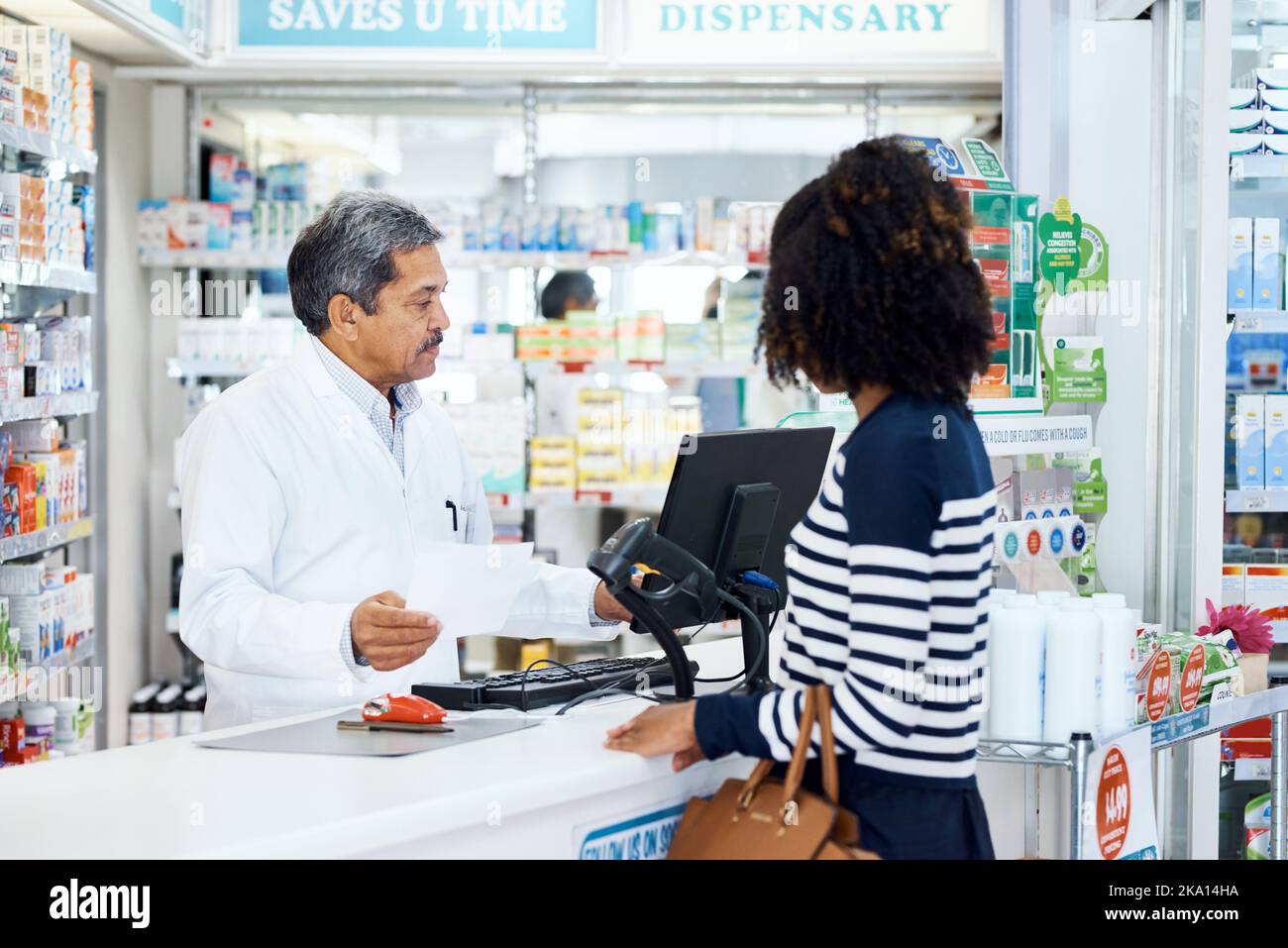 Let me check our system for these medication. a pharmacist assisting a ...