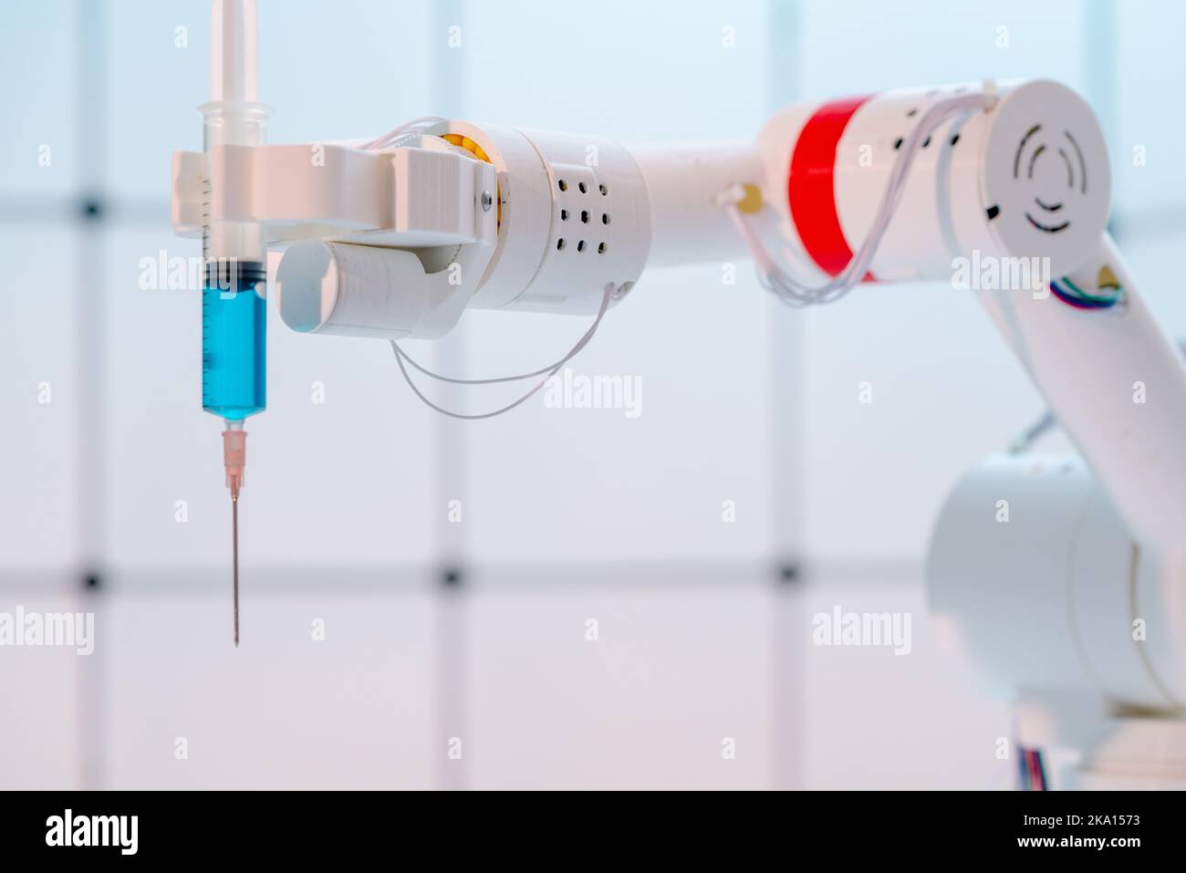 Robot hand with a medical syringe. Future medicine concept using robots ...