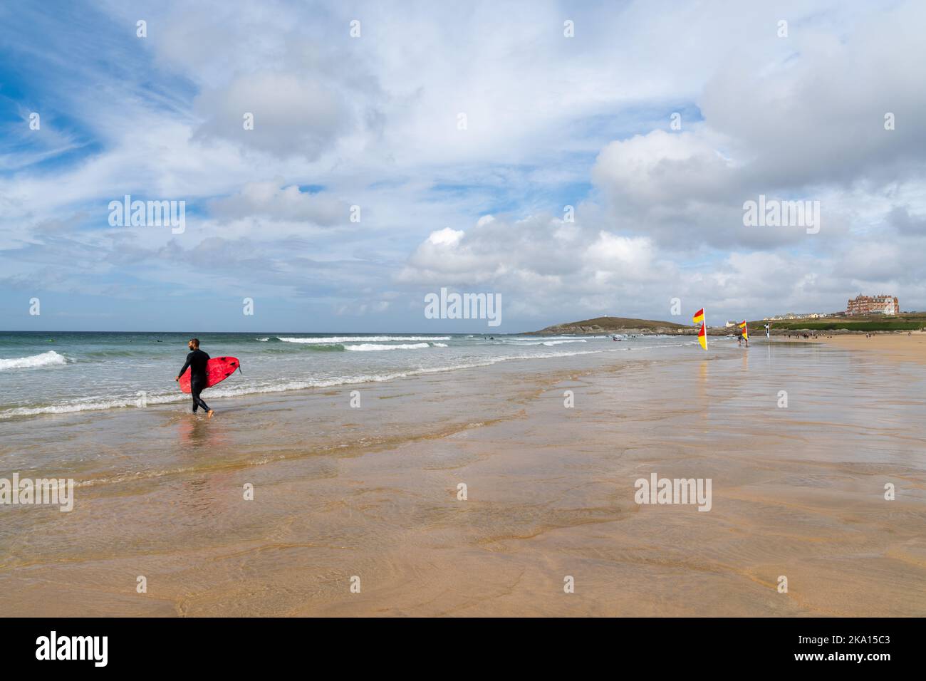 Newquay, United Kingdom - 4 Spetember, 2022: surfer with pink surfboard ...