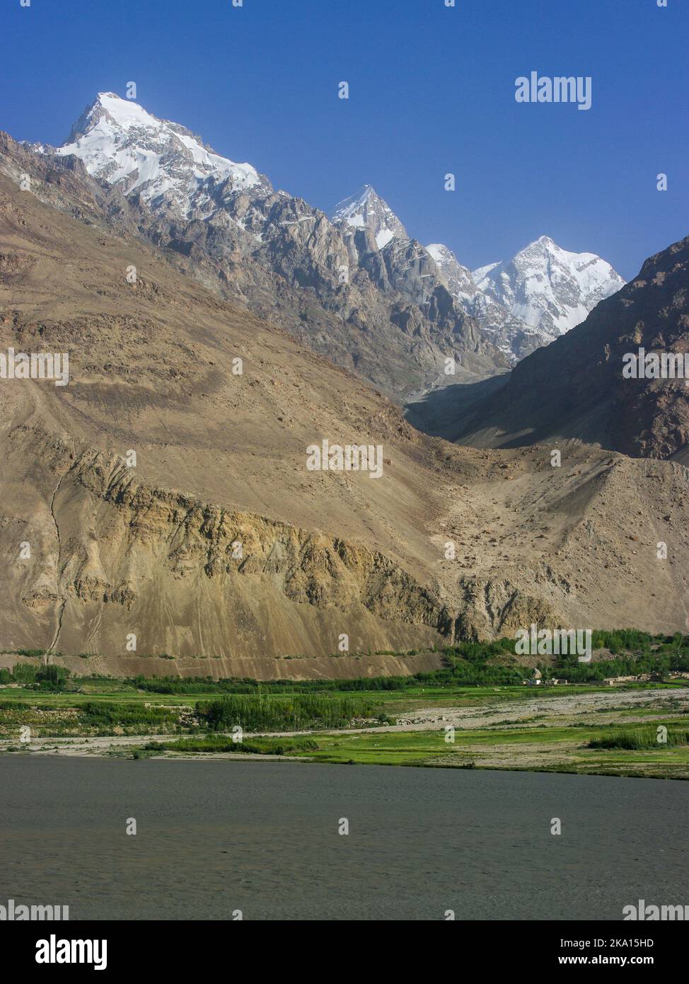 Landscape view of Hindu Kush snow-capped peaks on Afghan side of Panj ...