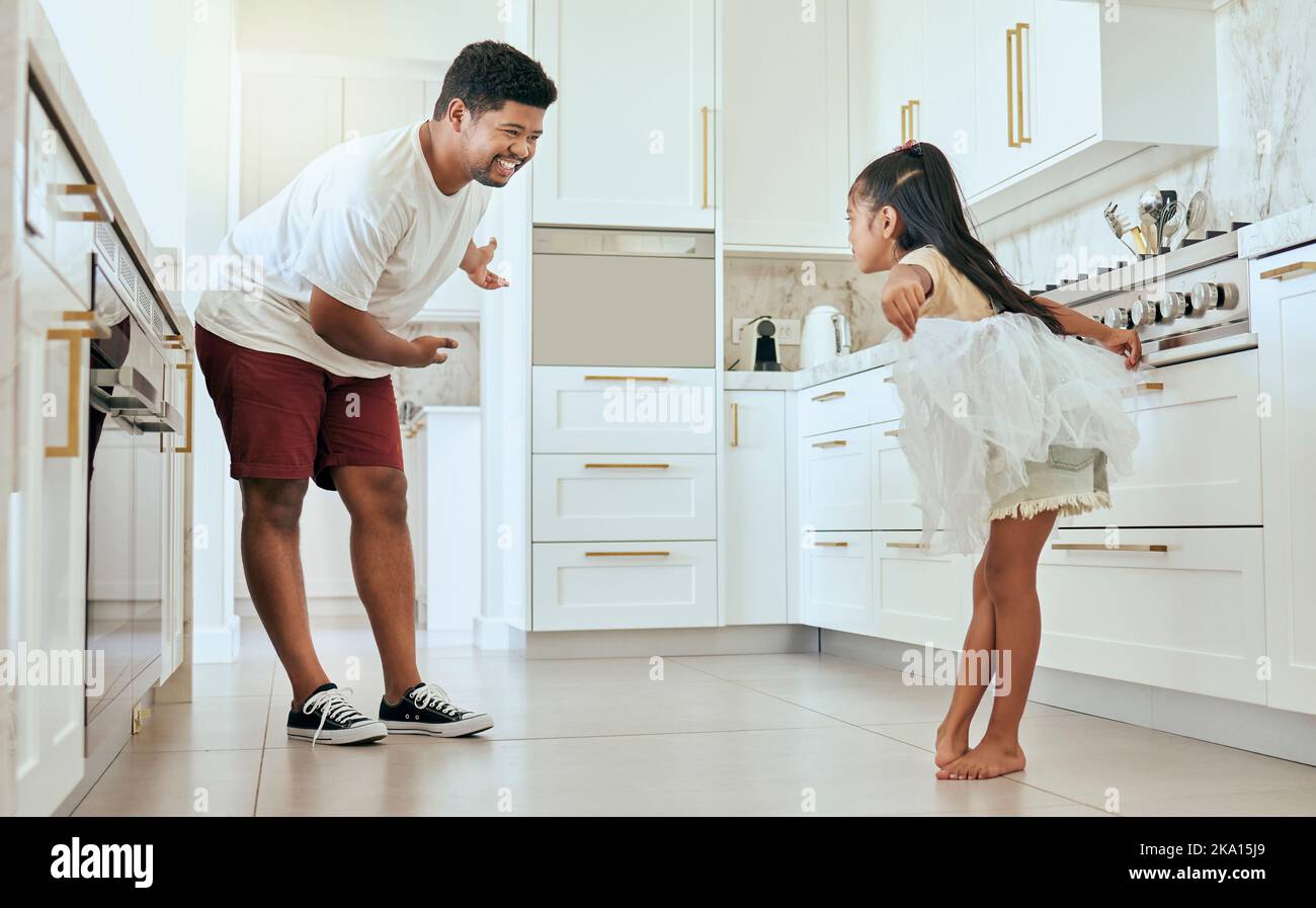 Family, dance and girl with father in kitchen for ballet, fun and bonding in their home together ...