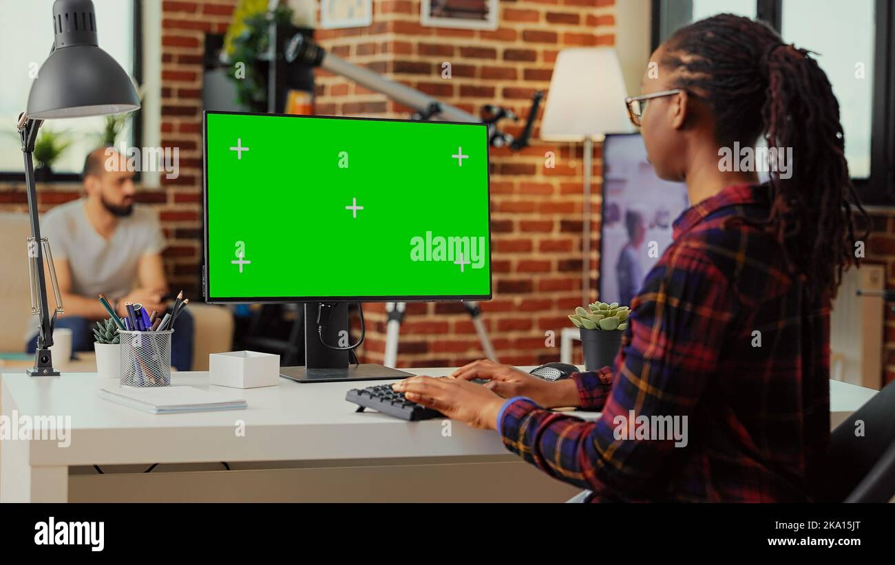 African american person using monitor to check with greenscreen ...