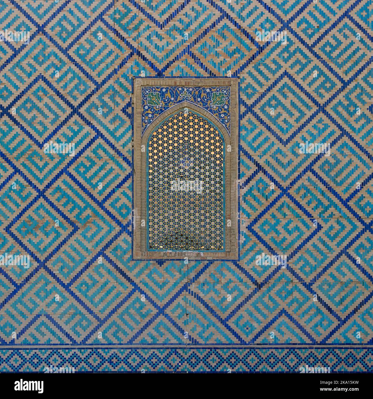 Blue and turquoise mosaic decor and latticework window on exterior wall ...