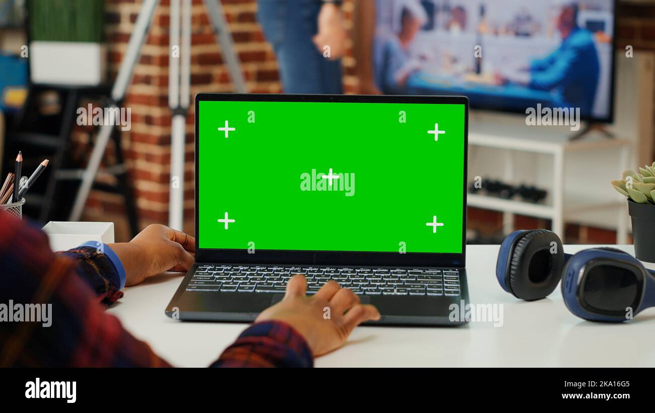 African american employee working with greenscreen template on laptop ...