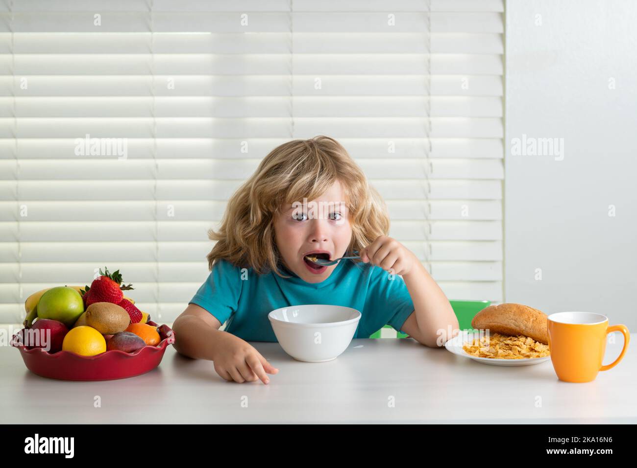 Little child boy having healthy breakfast. Kids nutrition and ...
