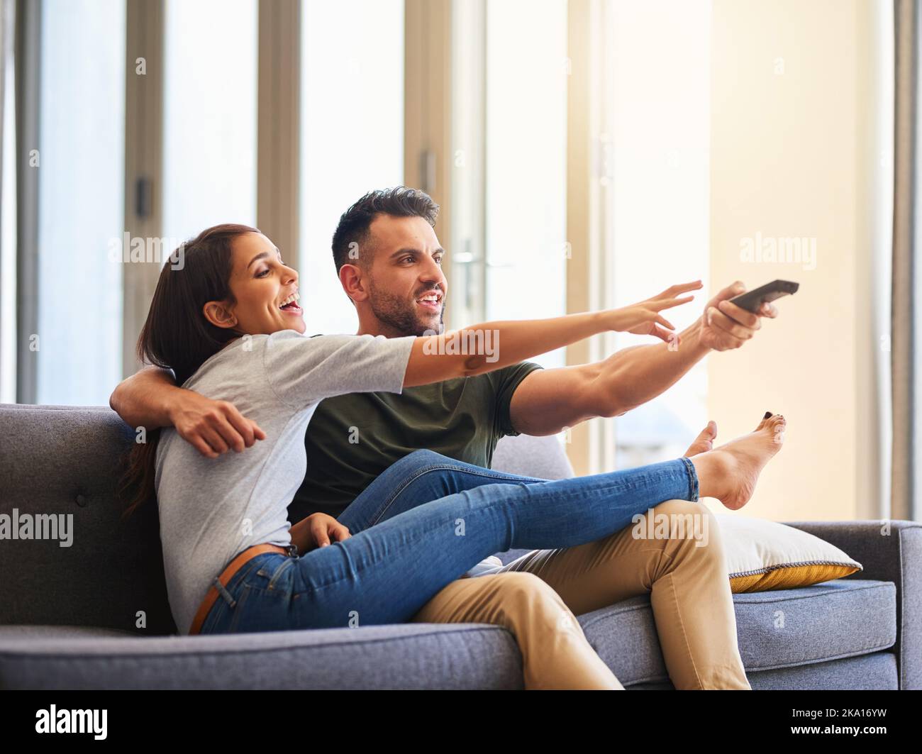 The battle of choosing what to watch. a young couple fighting over the ...