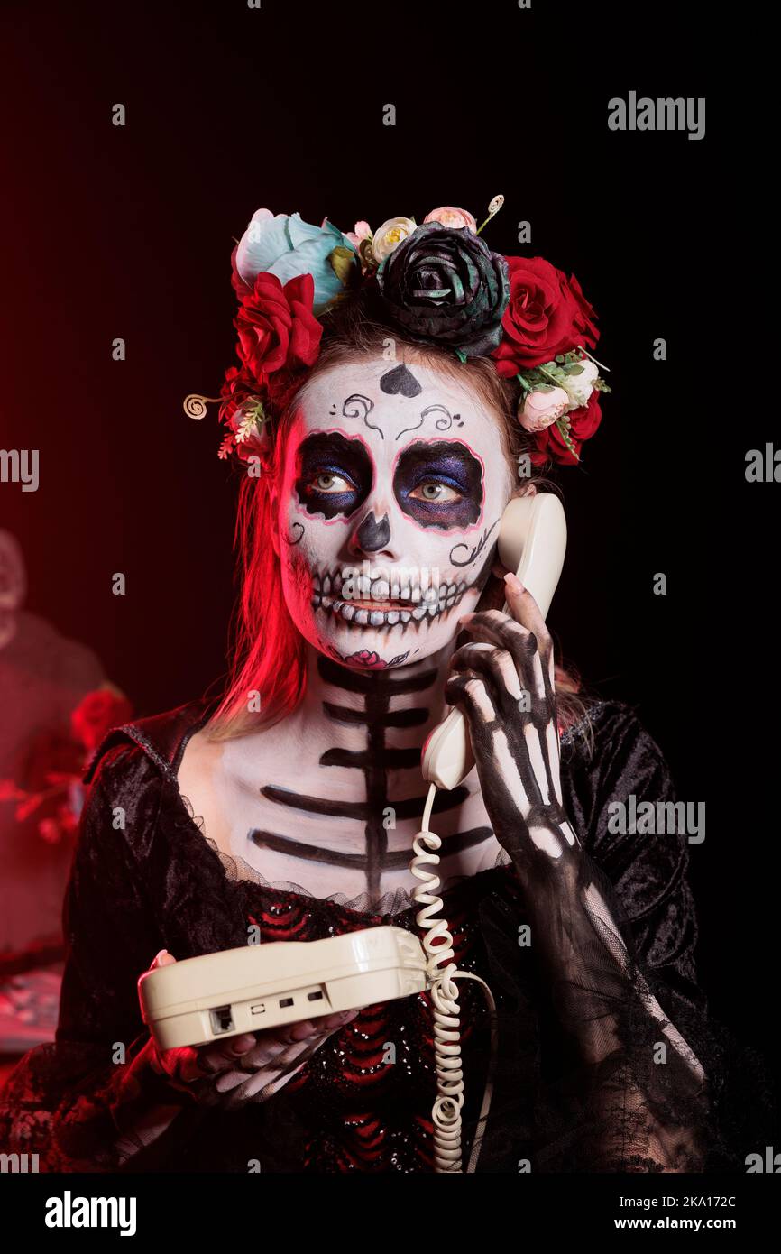 Scary young model answering landline phone call, standing over black ...