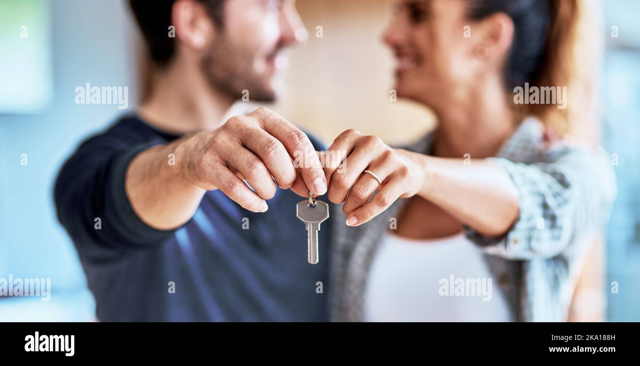 They now own a home together. an unrecognizable couple holding up the ...