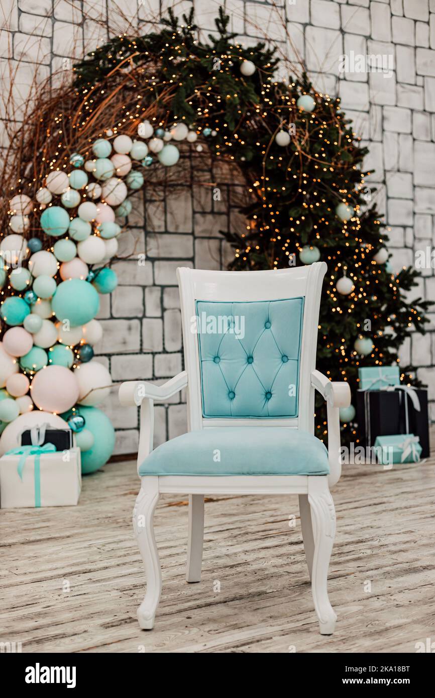 Blue chair in the Christmas interior. Christmas Arch with balloons ...