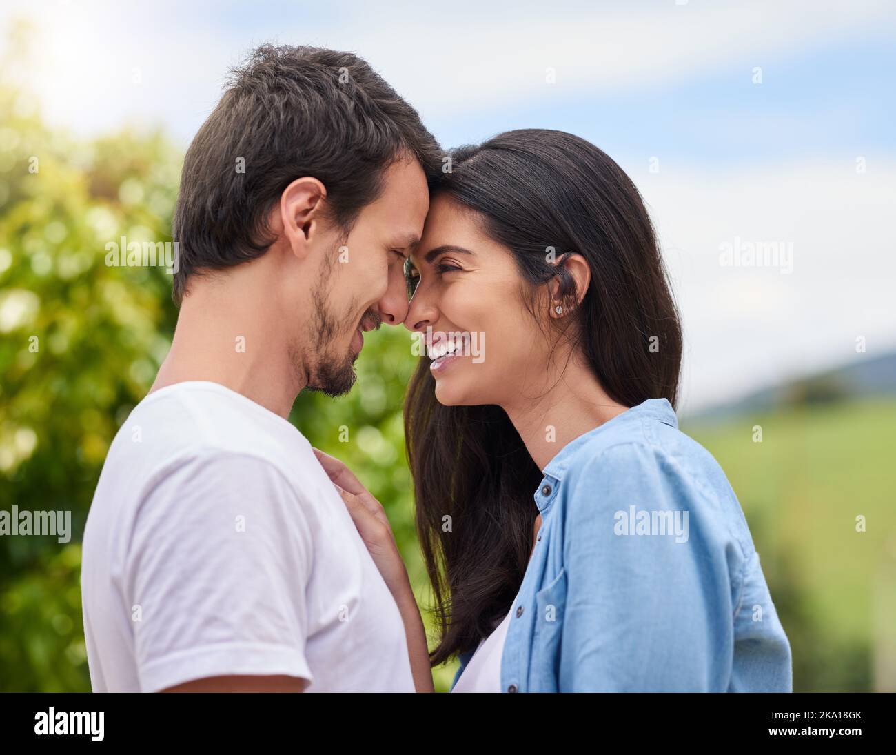 Getting lost in love. an affectionate young couple embracing while ...