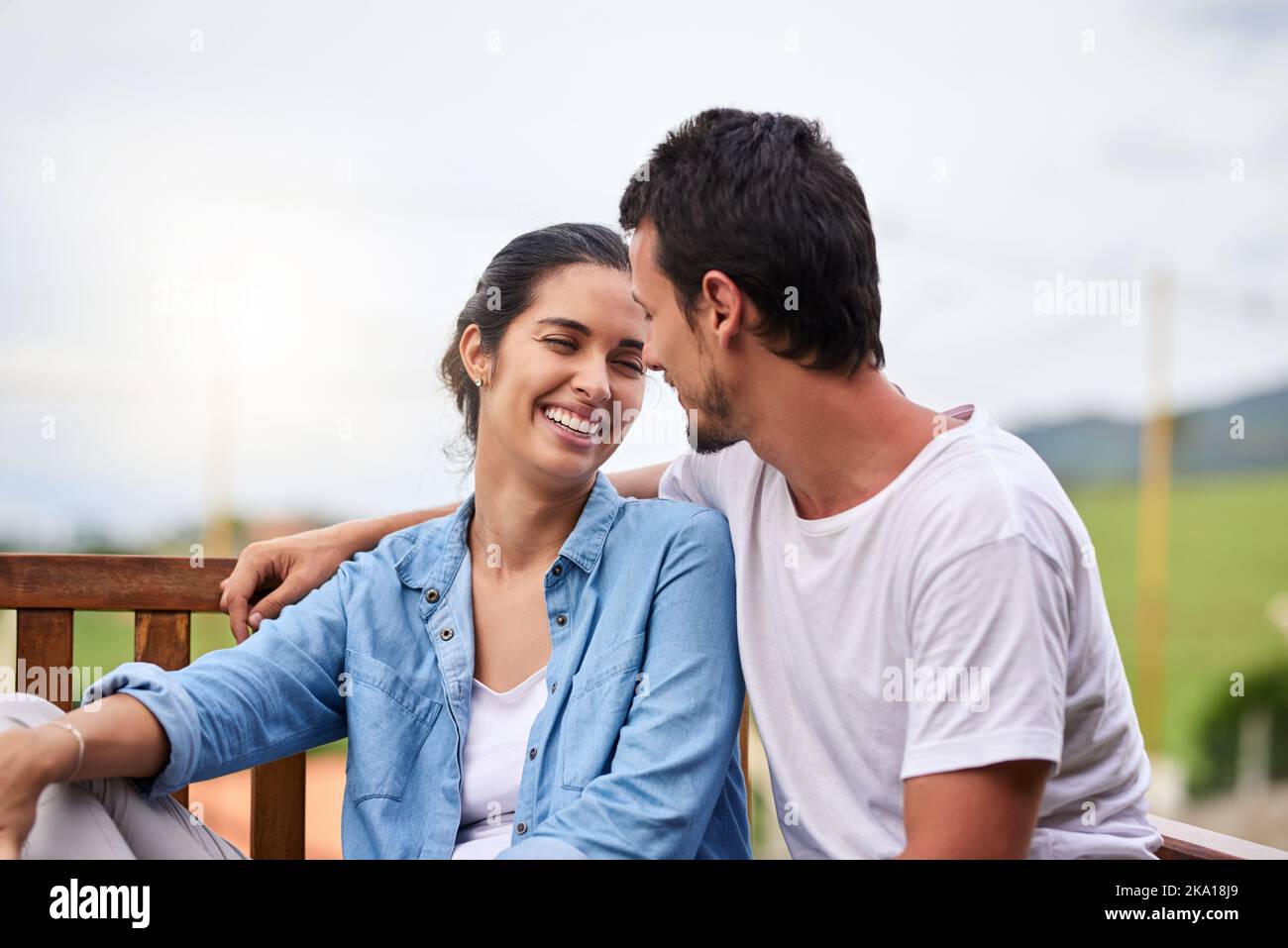 Its a match made in heaven. an affectionate young couple sitting on a ...