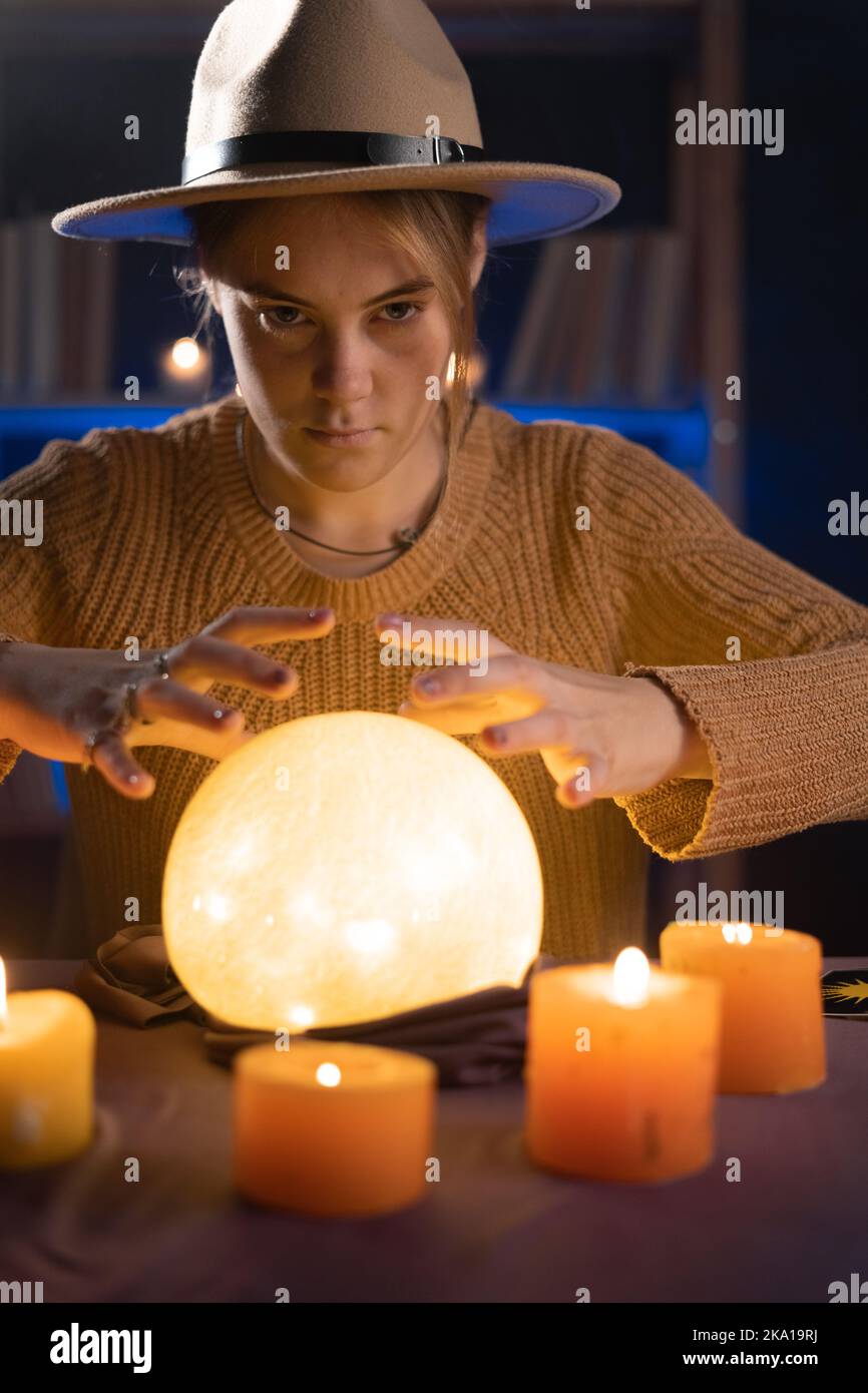 Soothsayer Using Crystal Ball To Predict Future At Table In Darkness