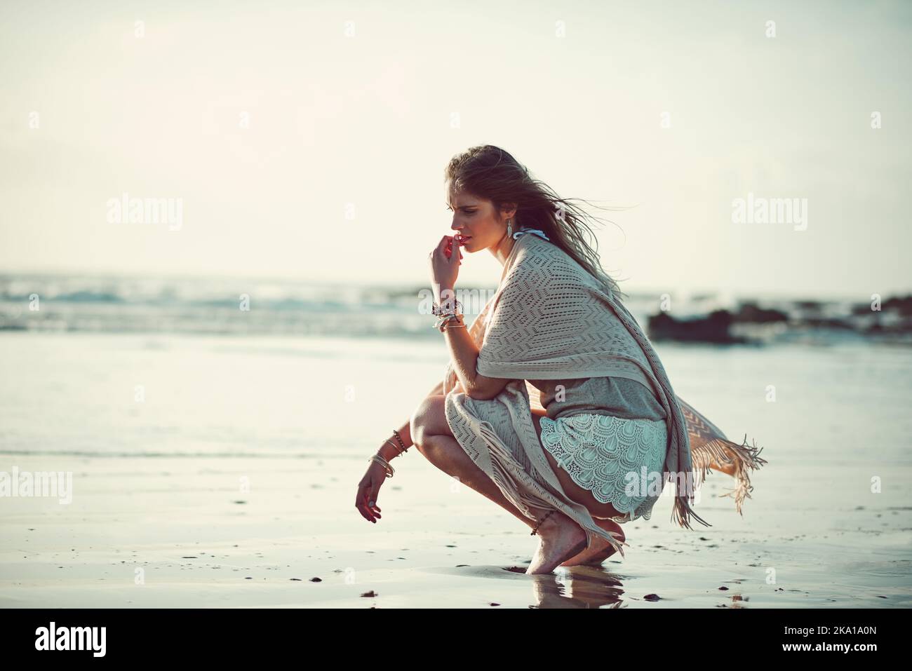 Contemplate in the comfort of the sea. an attractive young woman ...