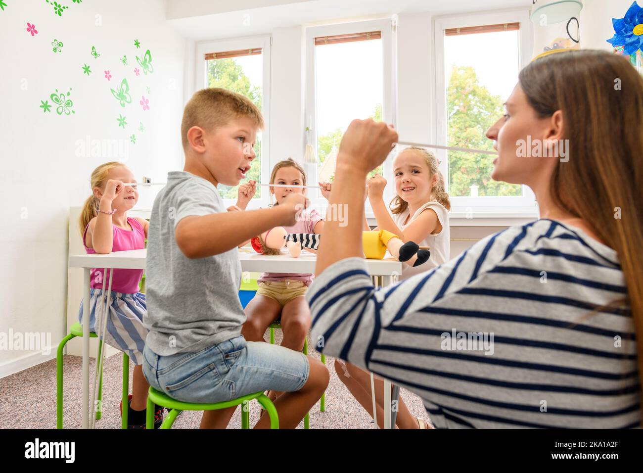 Child occupational therapy session. Group of children doing playful ...