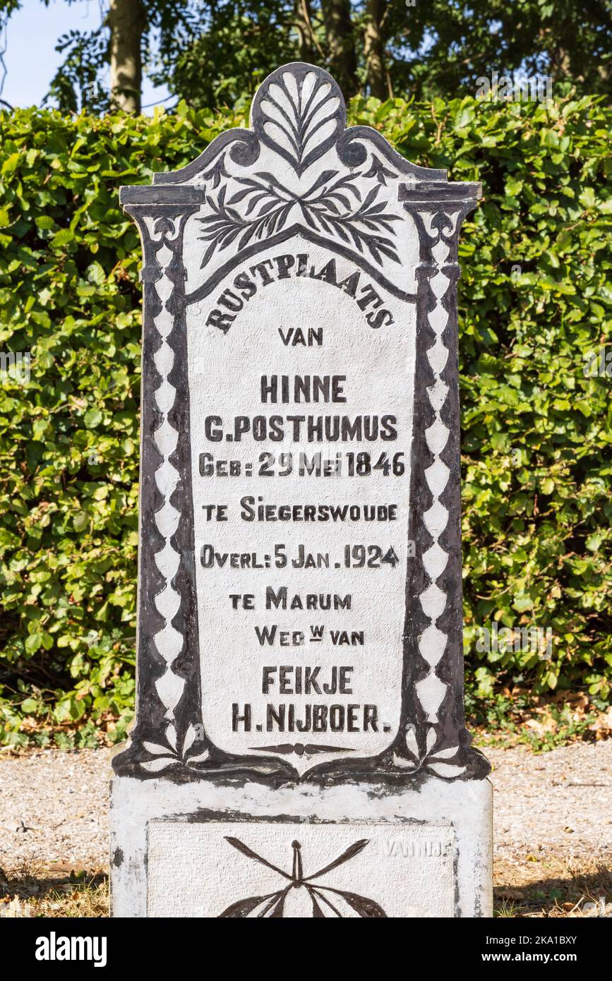 Marum, The Netherlands - September 2, 2022: Old graves with palm tree ...