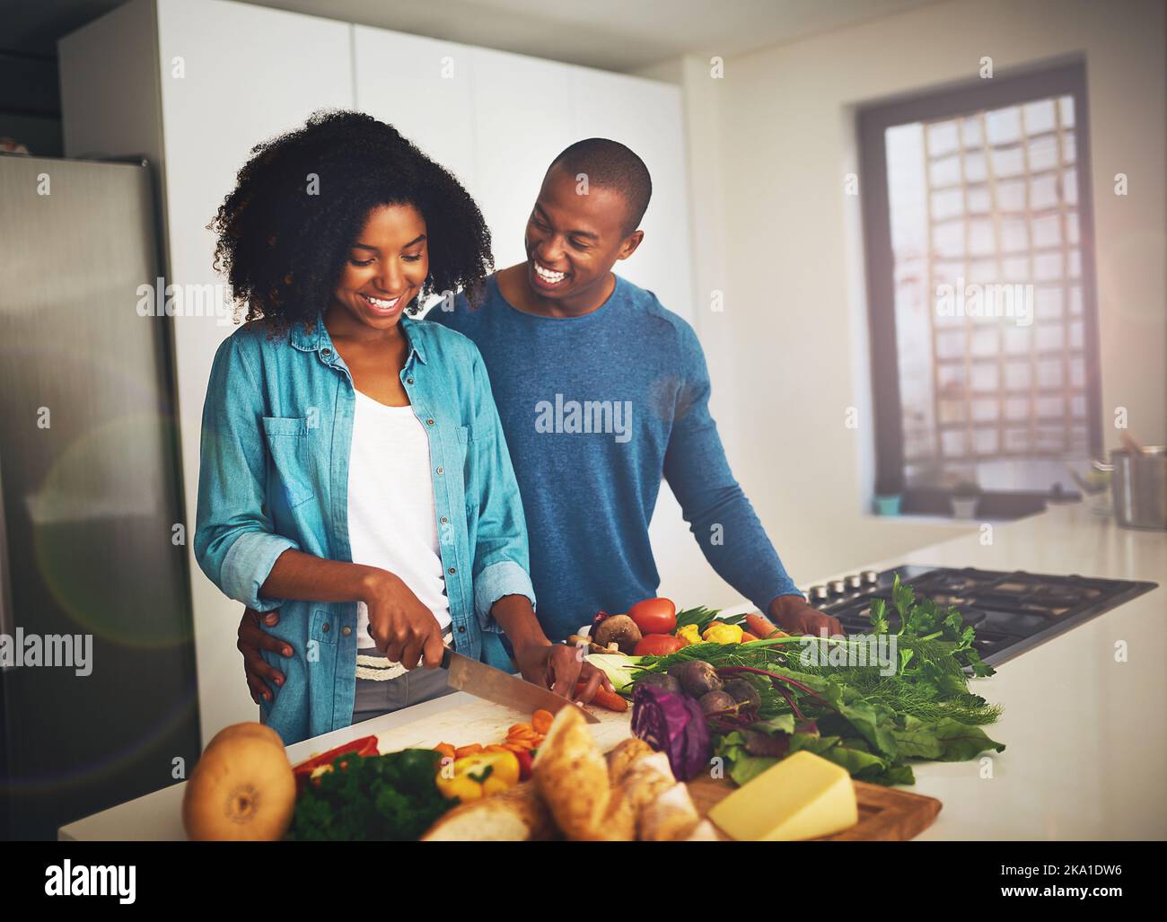 We are cooking up a storm. a cheerful young couple preparing food ...