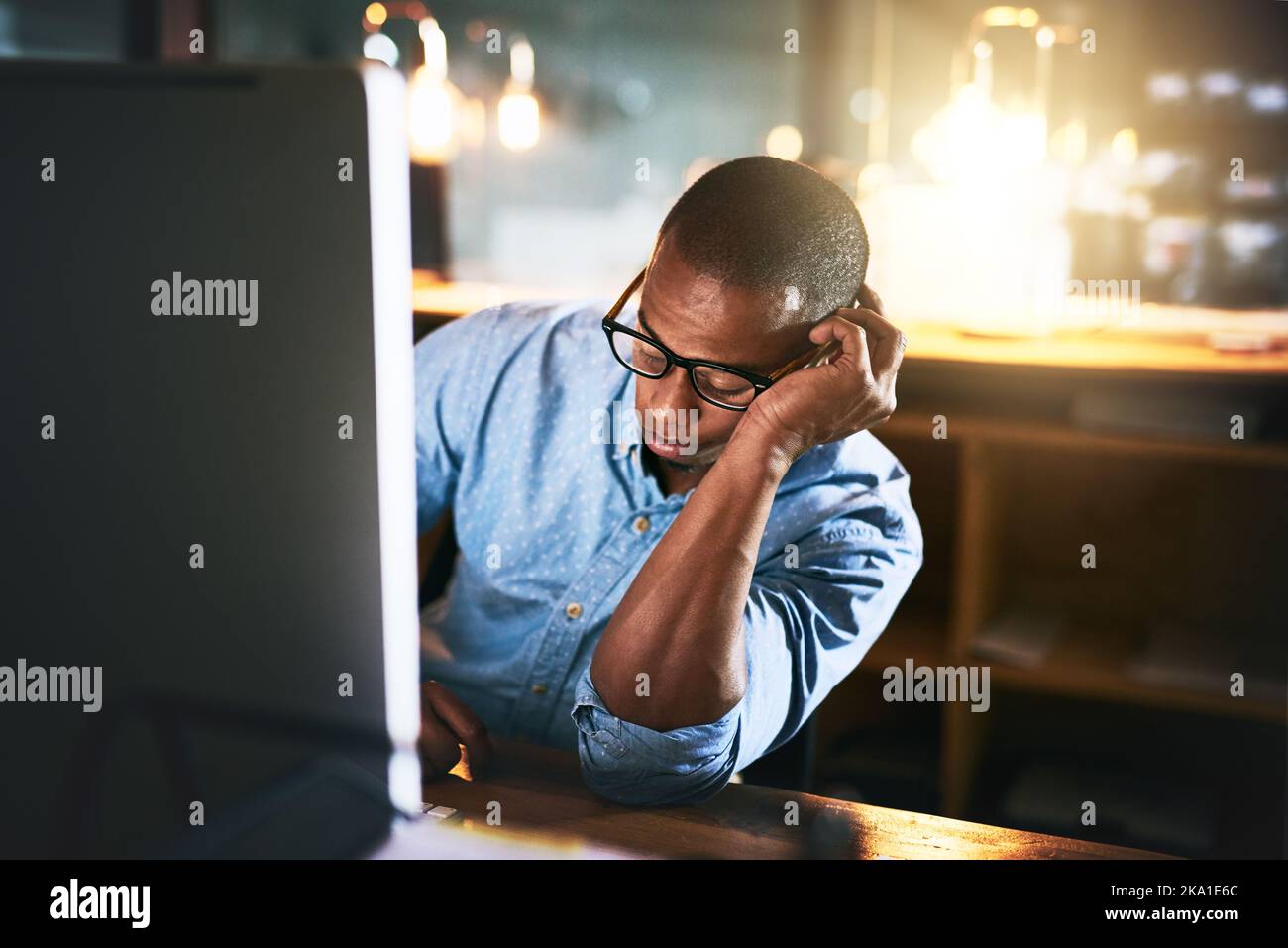 He should have logged off a long time ago. an exhausted young ...